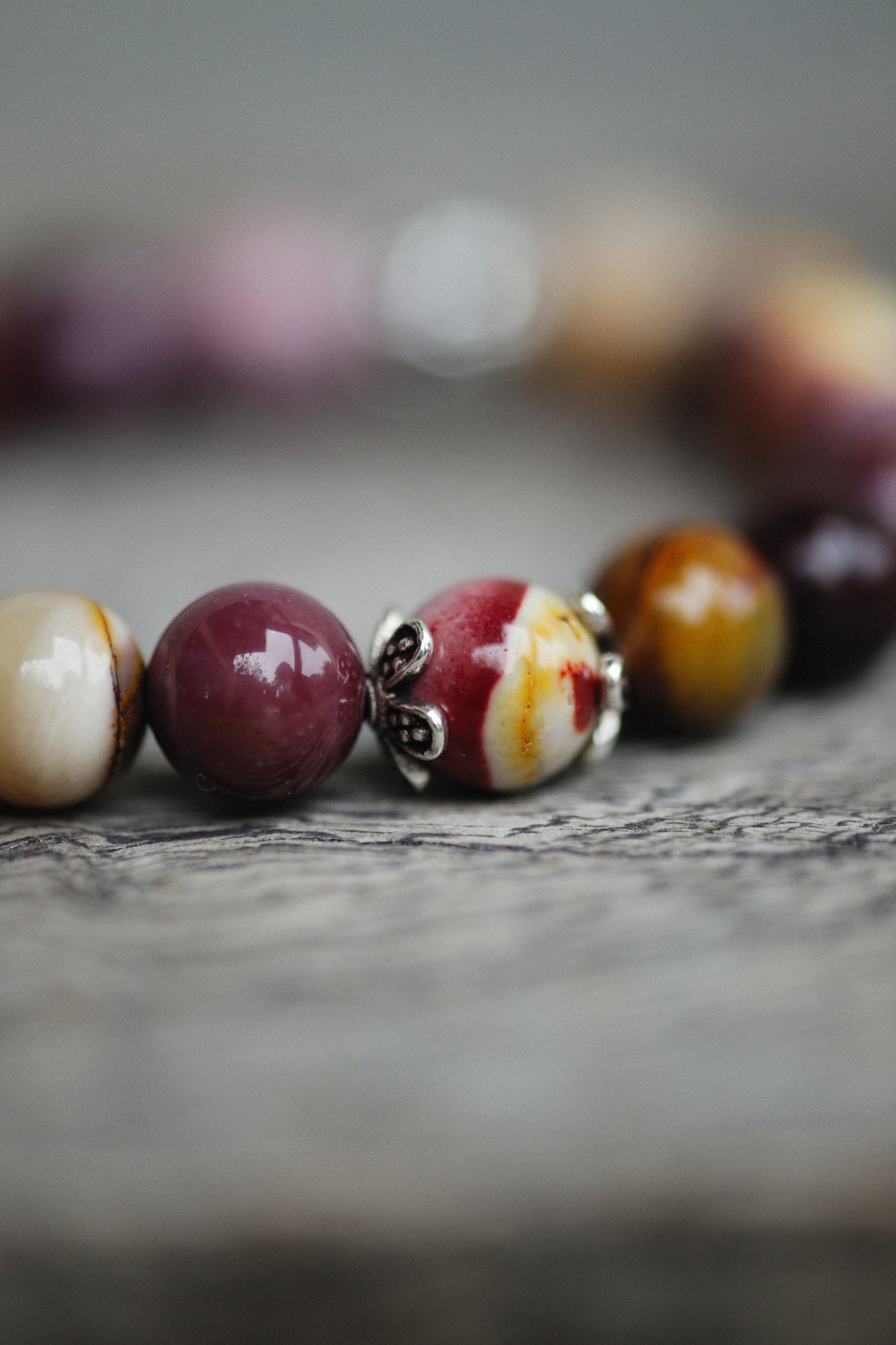Close Up Photo of Beaded Accessories on Gray Surface · Free Stock Photo