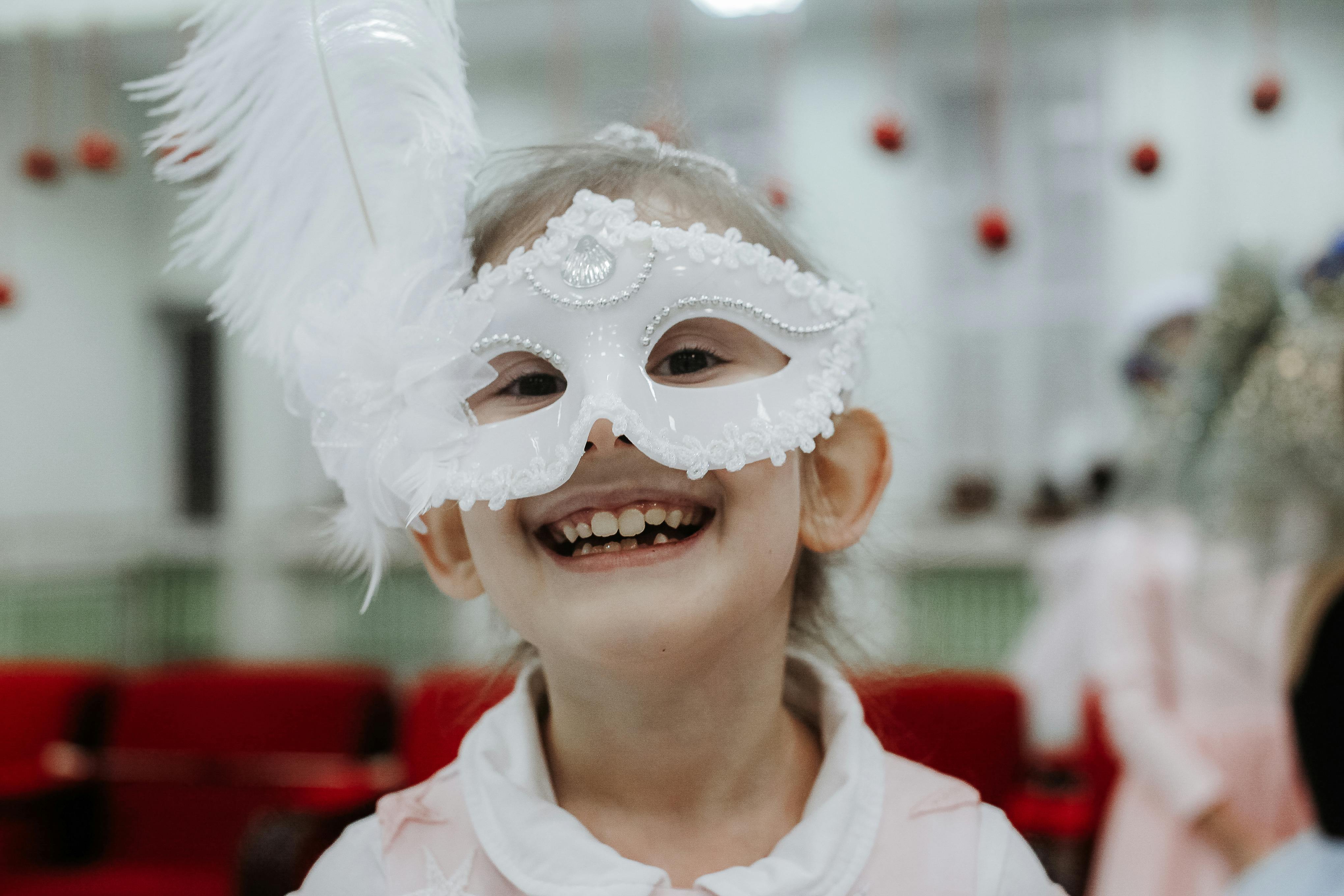 Little Girl in a Carnival Mask Laughing · Free Stock Photo