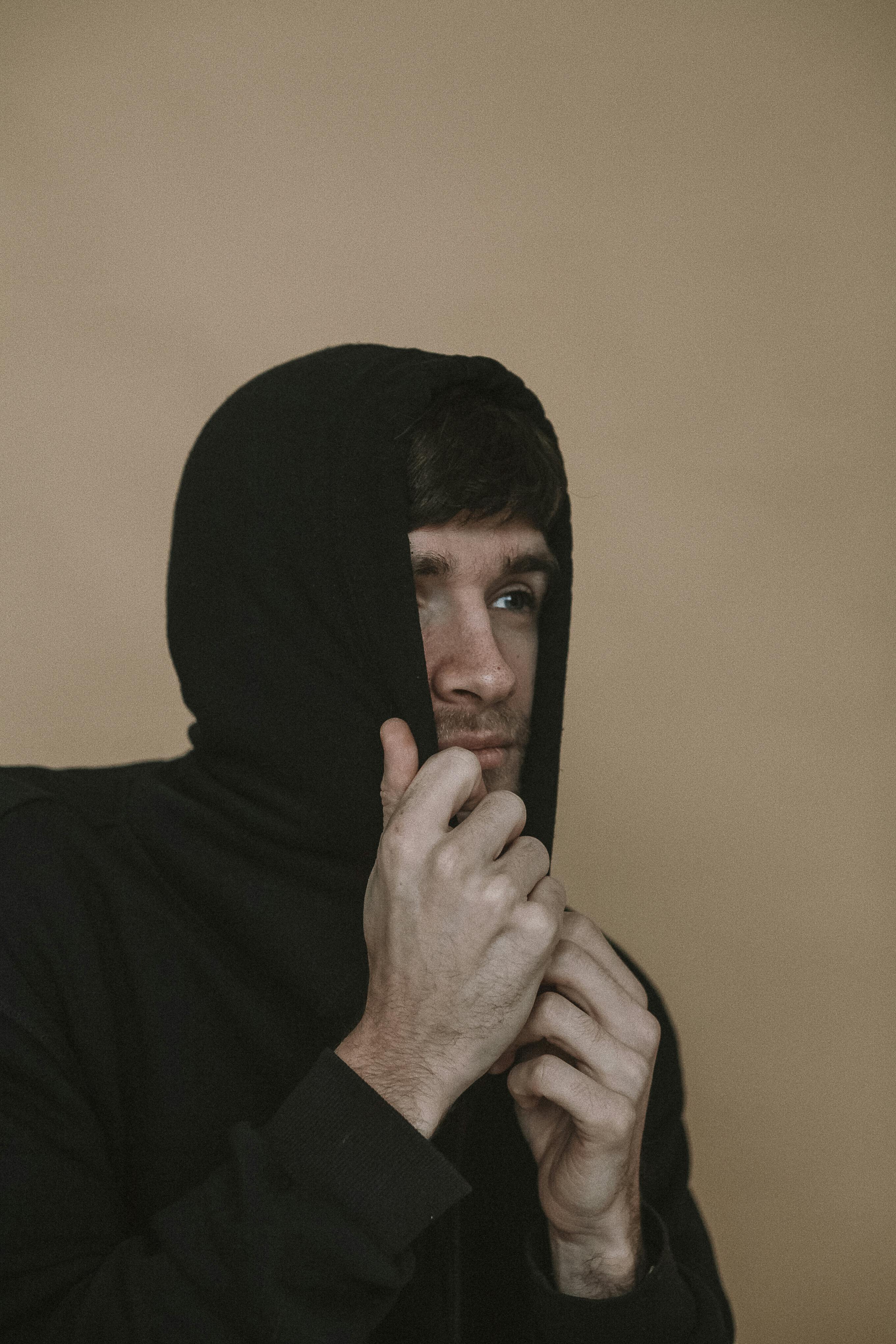 Man in Black Jacket Covering his Face with his Hoodie · Free Stock Photo