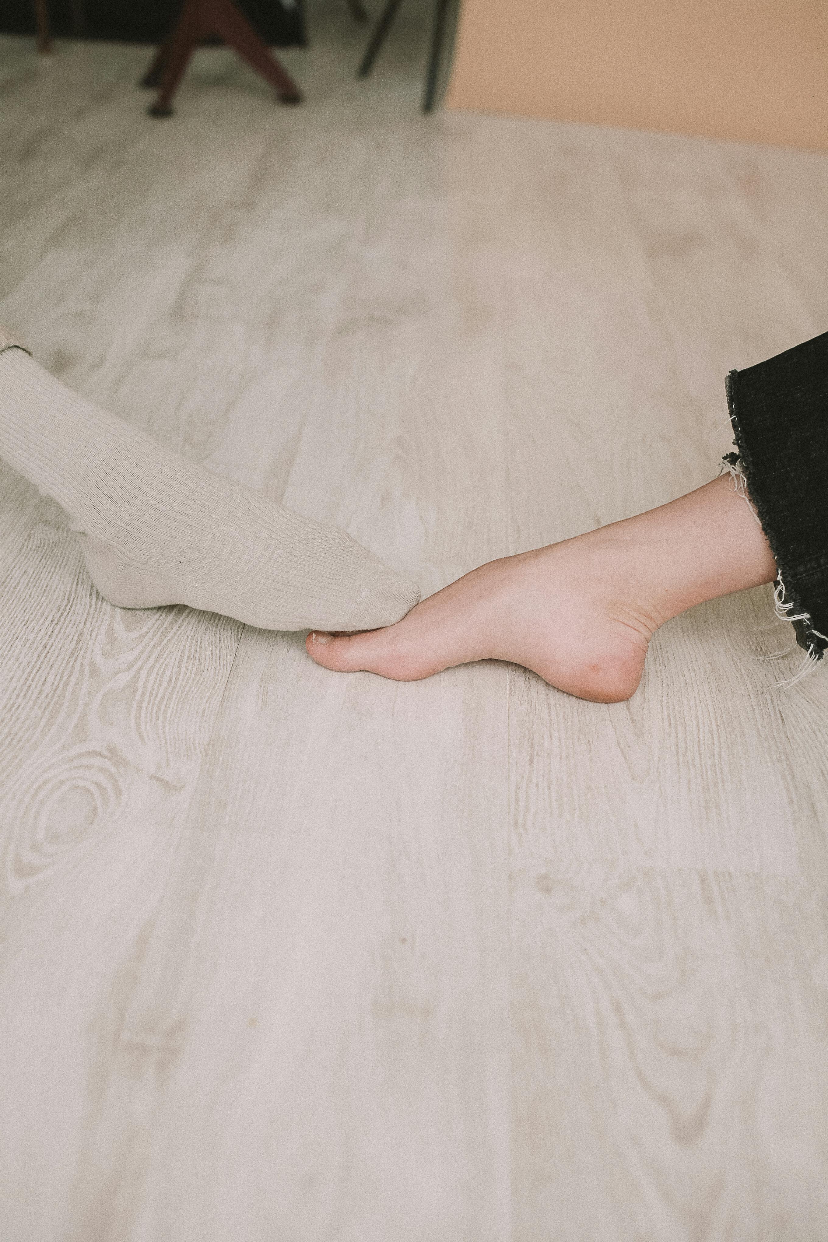 People Touching Feet across Floor · Free Stock Photo