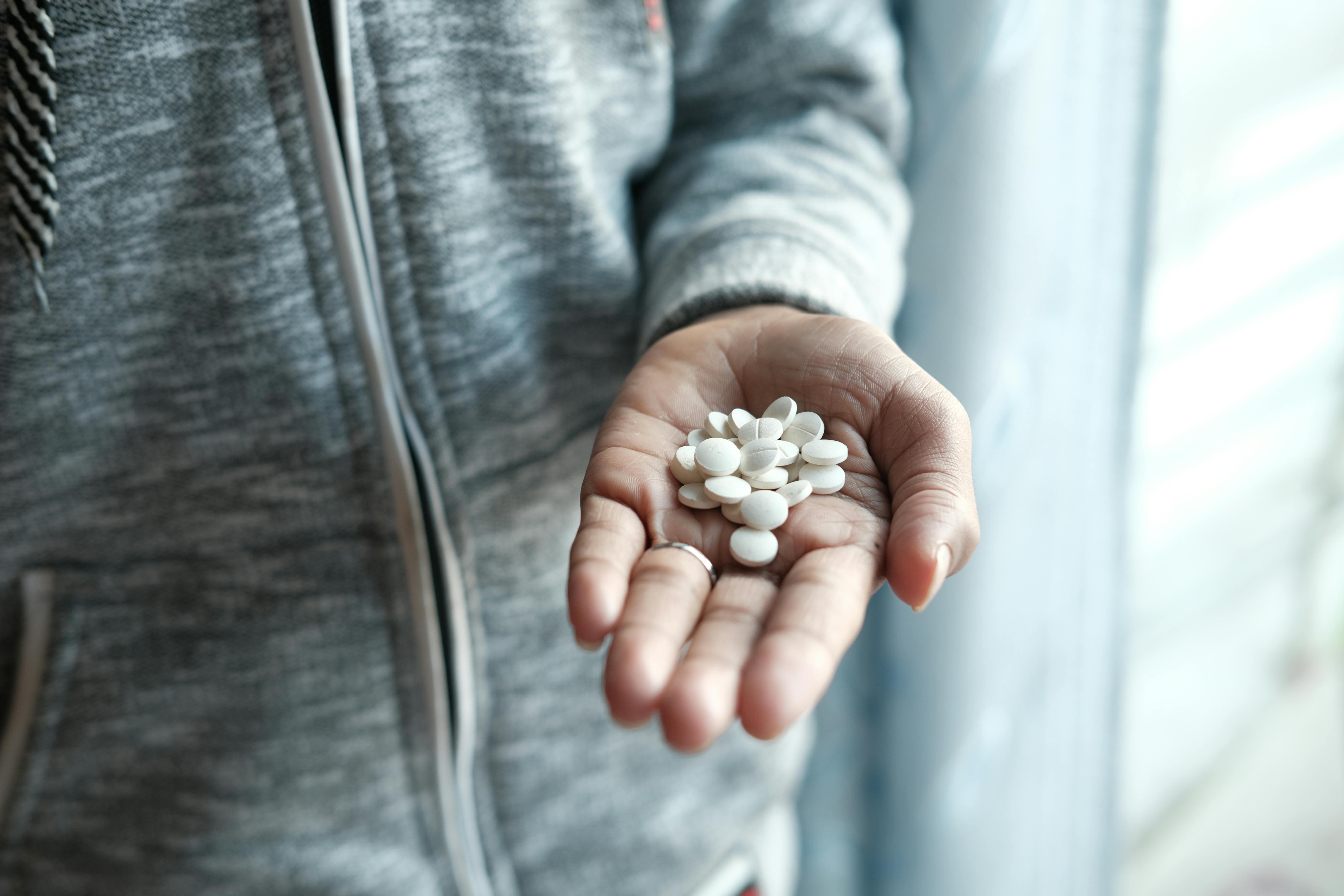 Person Holding White Round Medication Tablets · Free Stock Photo