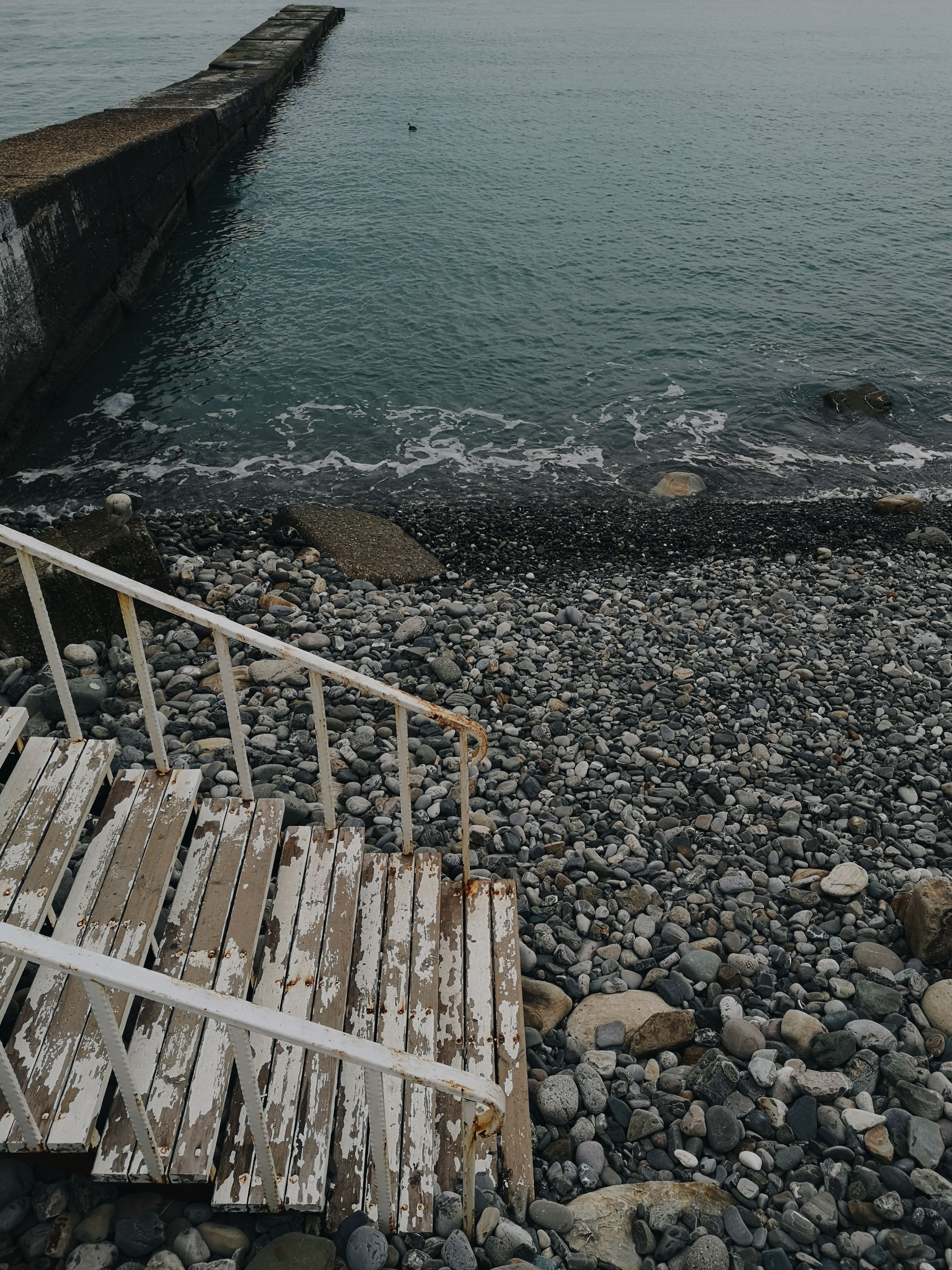 Seashore with Pebbles and Weathered Stairs · Free Stock Photo