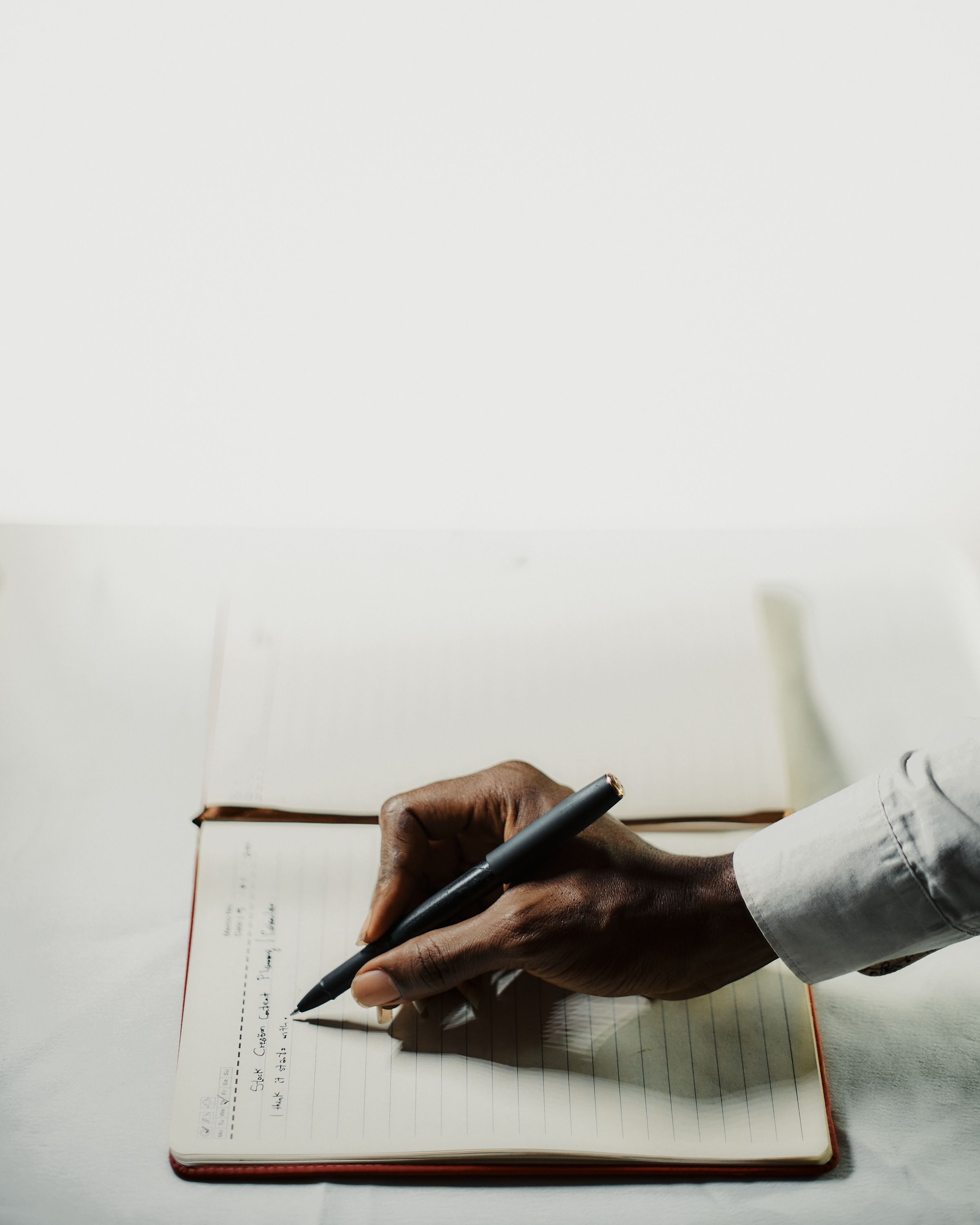 Person Writing on White Paper · Free Stock Photo