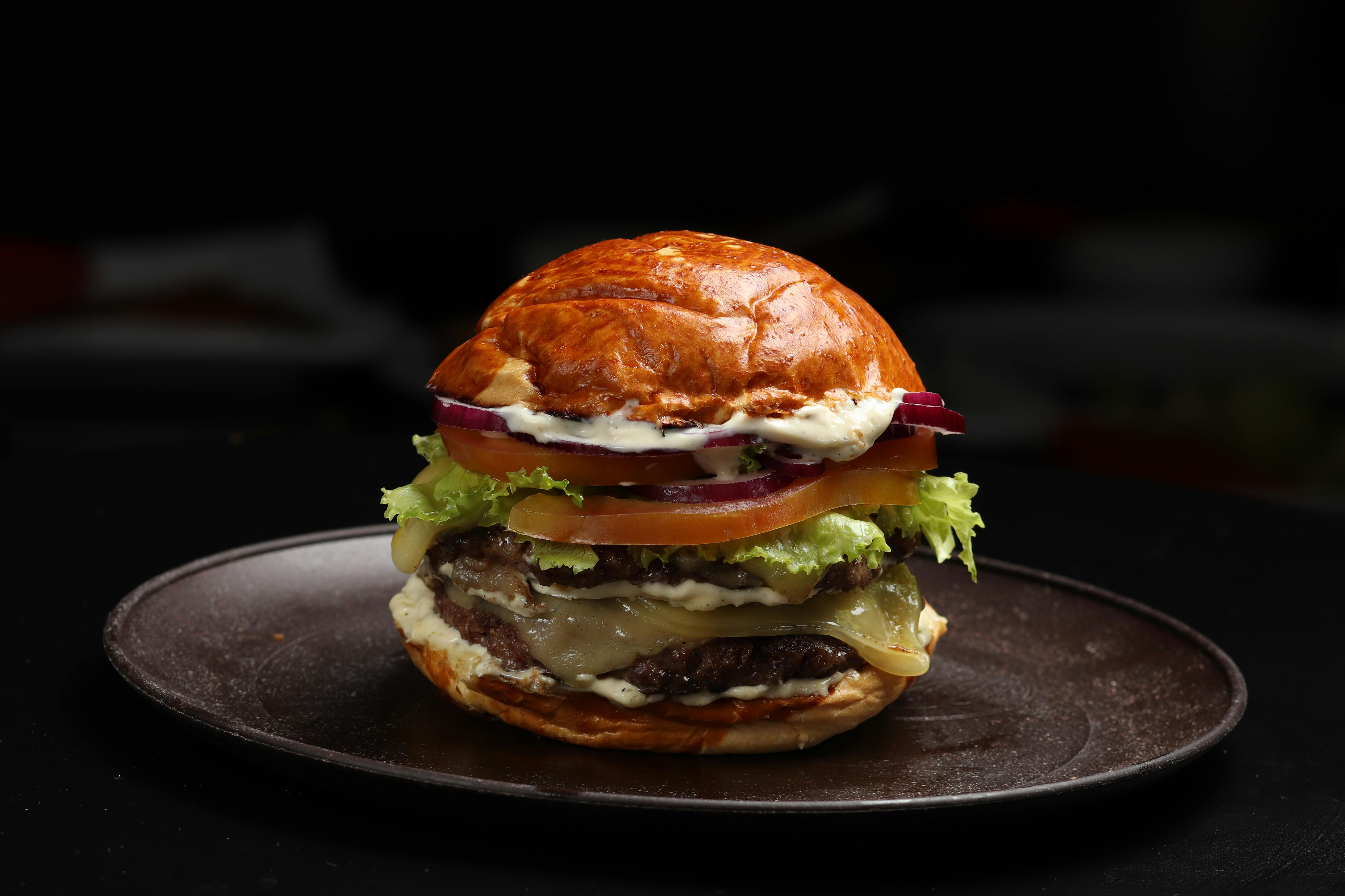 Close-Up Shot of a Bowl of Chips beside a Burger · Free Stock Photo