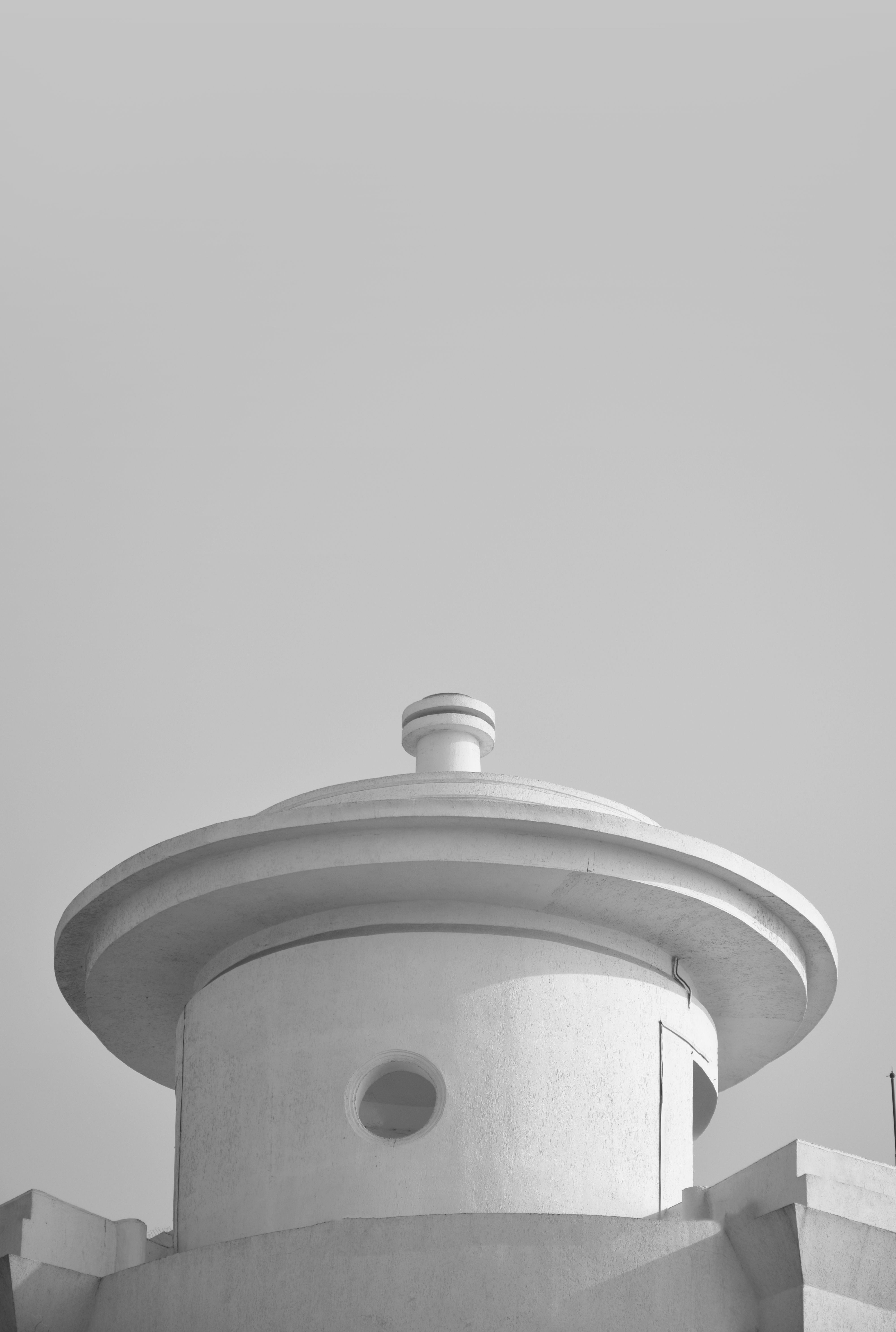 Grayscale Photo of a Round Building · Free Stock Photo