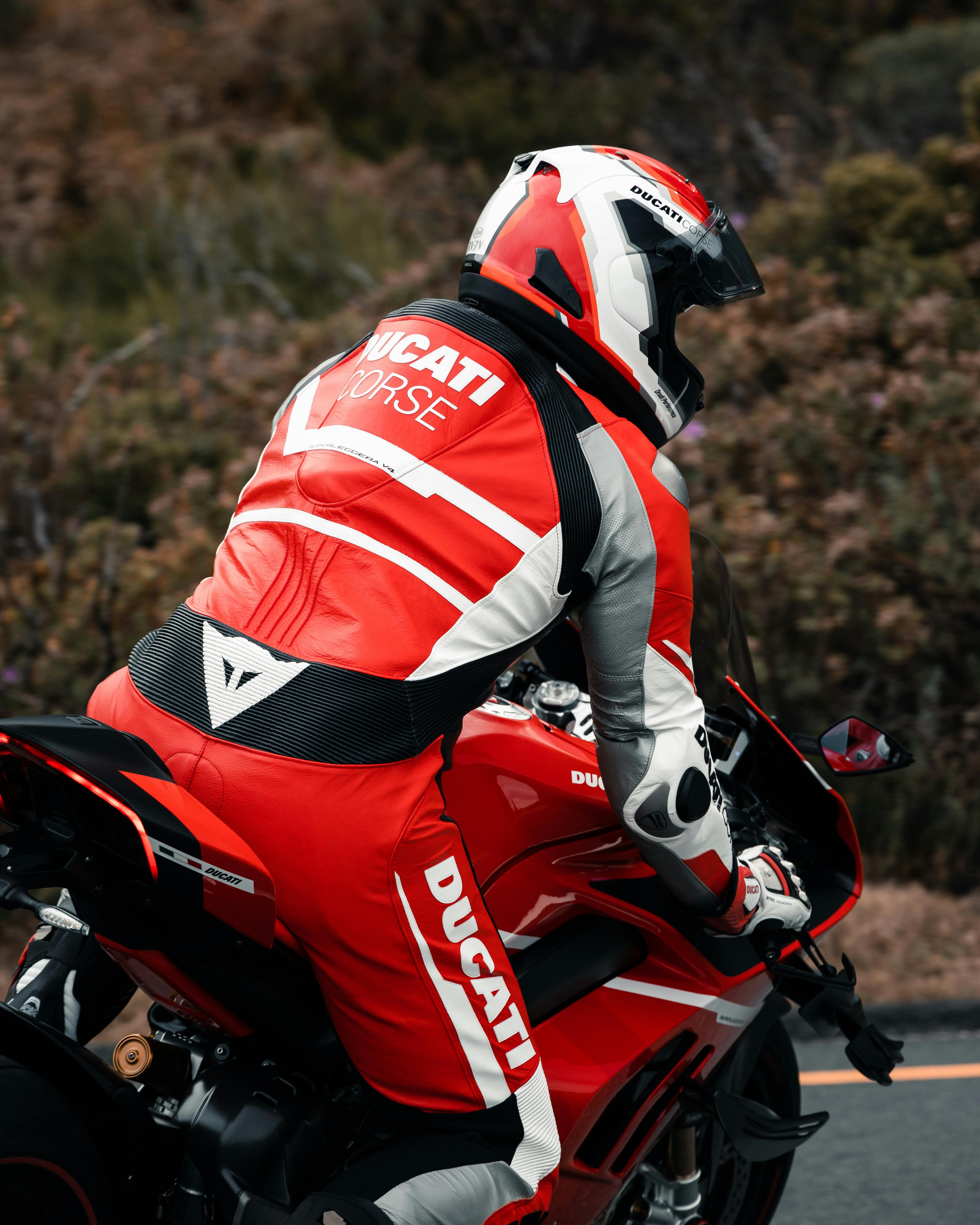 Man Wearing Racing Suit Riding a Sports Bike · Free Stock Photo