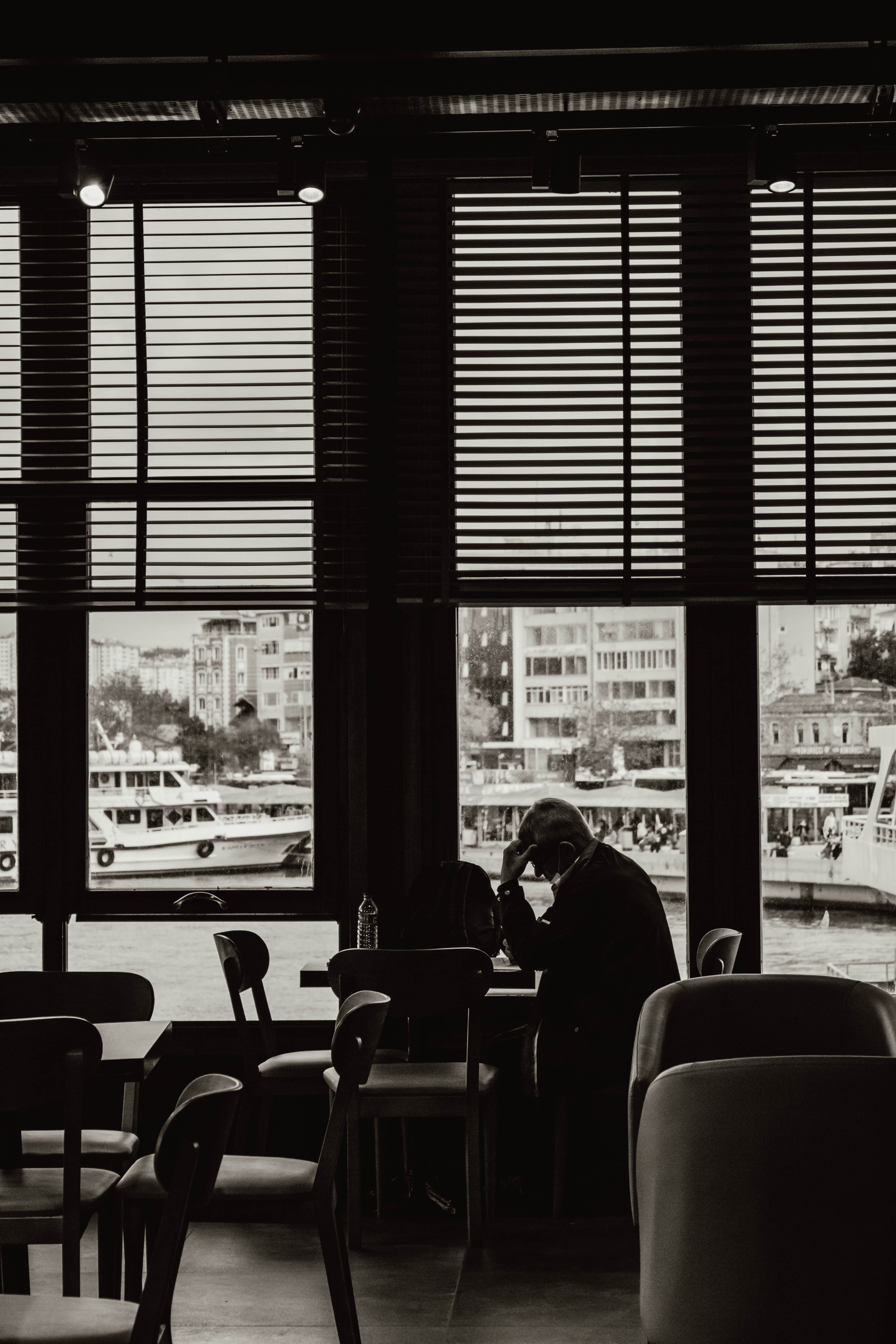 Monochrome Photo of Man inside a Cafe · Free Stock Photo