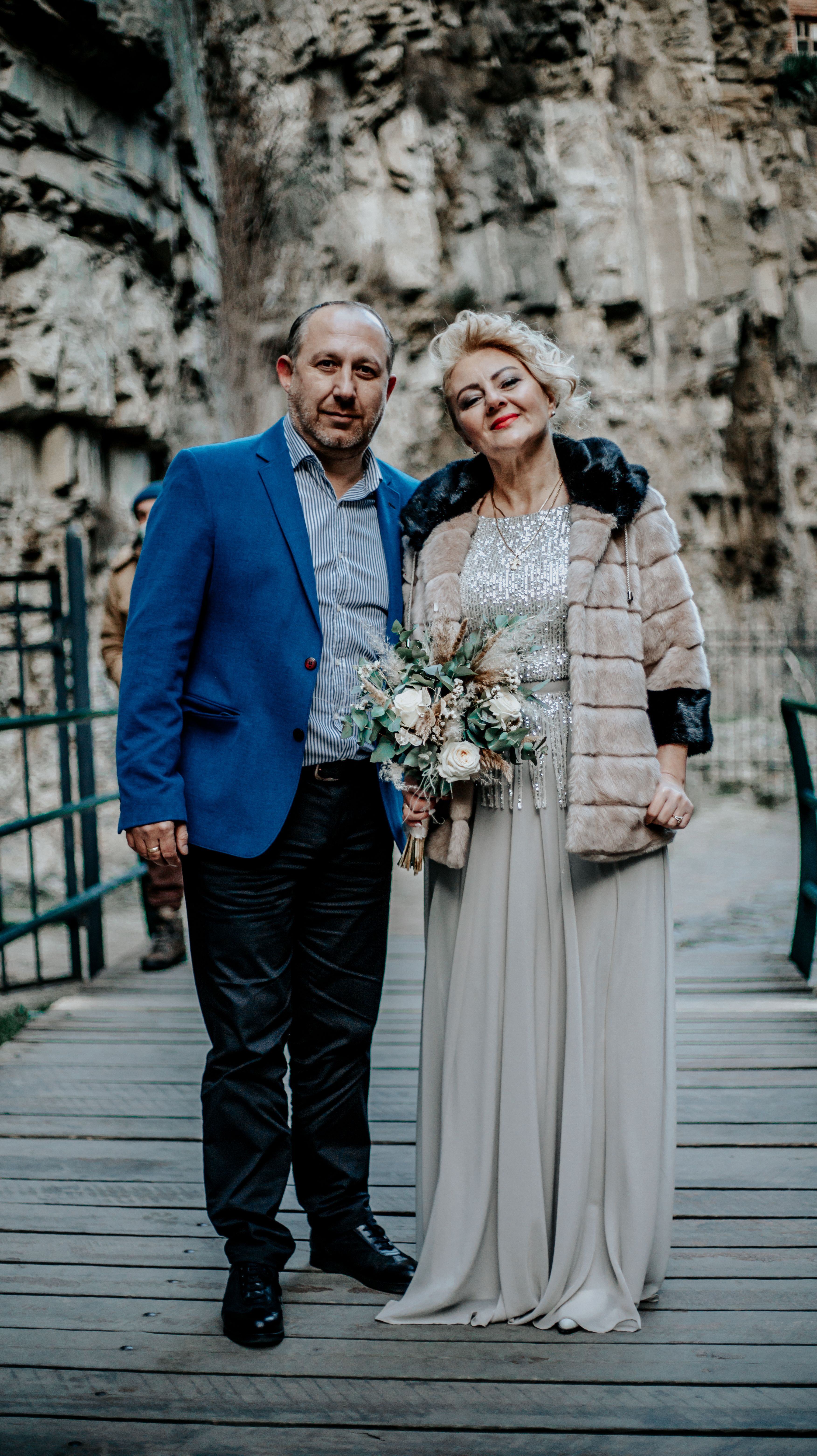 Couple Wearing Gown and Suit Jacket Standing and Pose for Picture ...