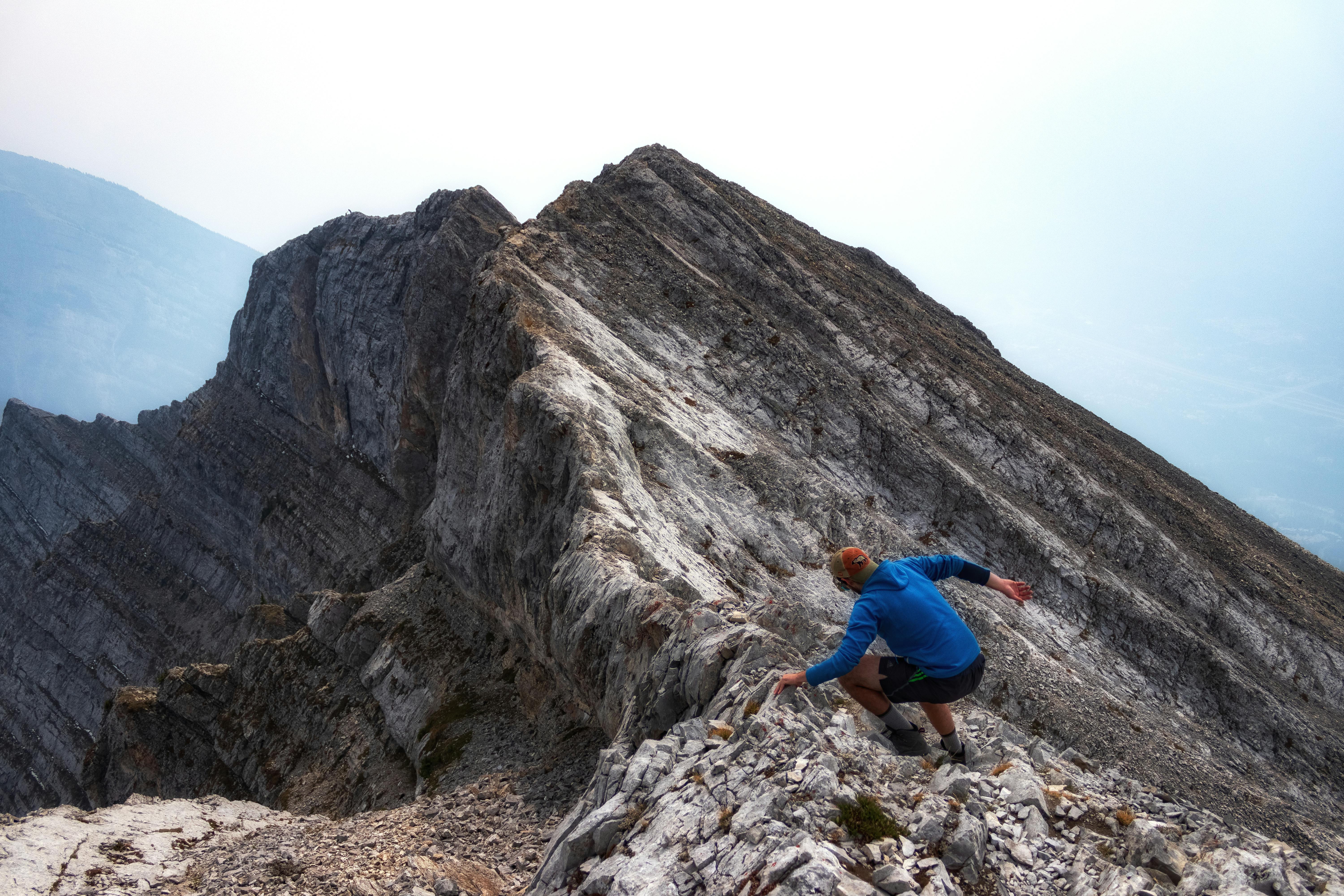 A Man Standing on the Rock Mountain · Free Stock Photo