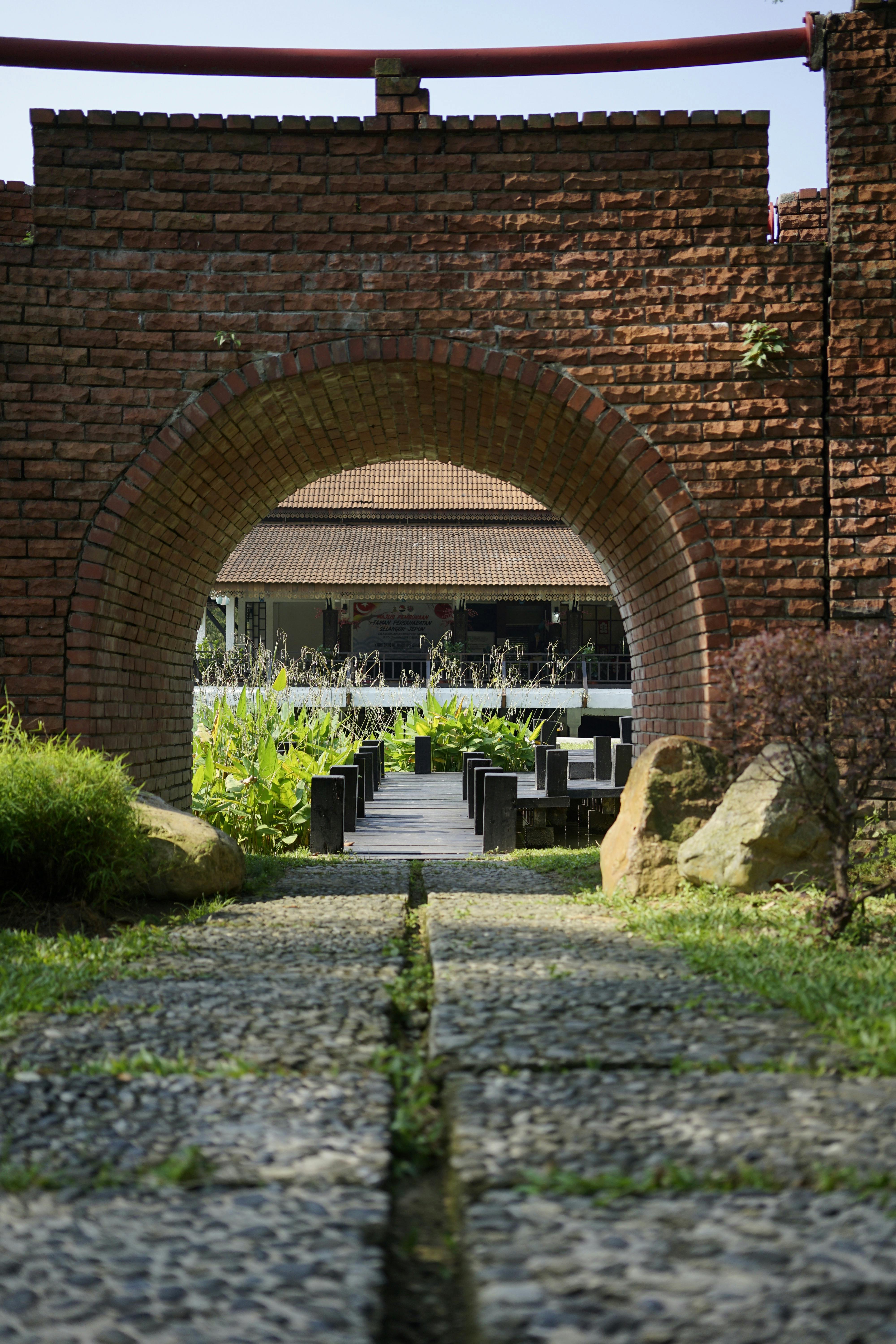 Pavement Path under Brick Arch · Free Stock Photo