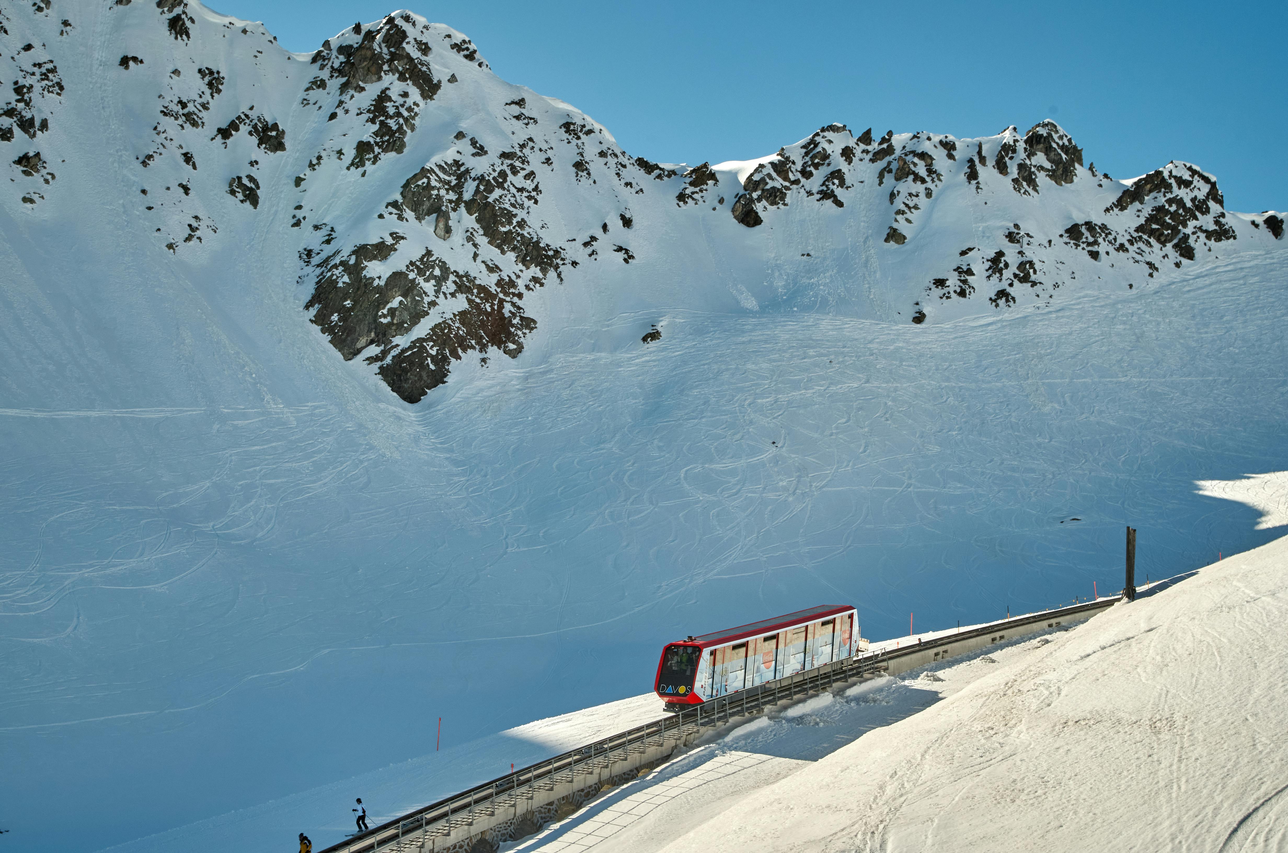 Red and Black Train on Rail Near Snow Covered Mountain · Free Stock Photo