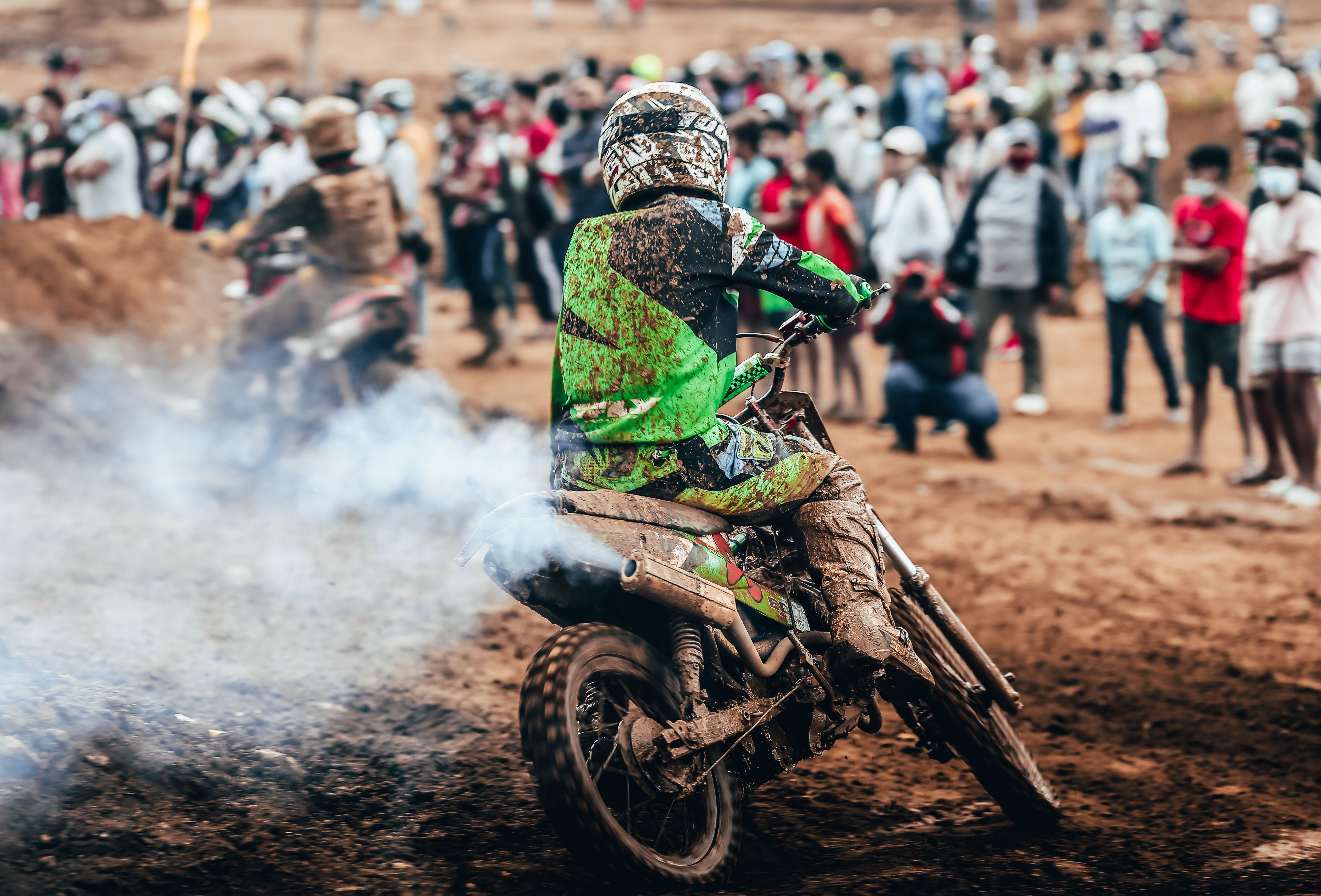 Man Wearing White Black and Orange Motorcross Suit · Free Stock Photo