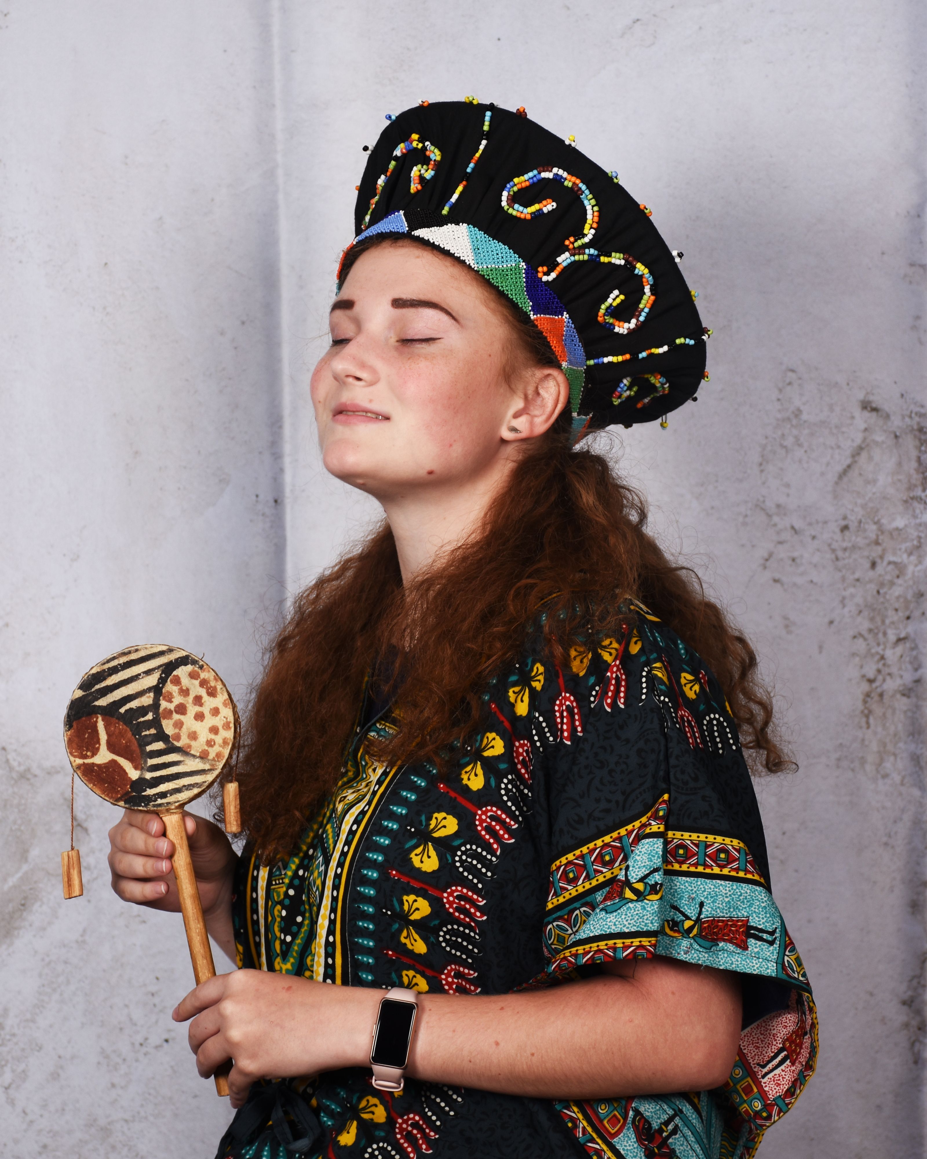 Woman in Traditional Clothes Holding a Percussion Instrument · Free ...
