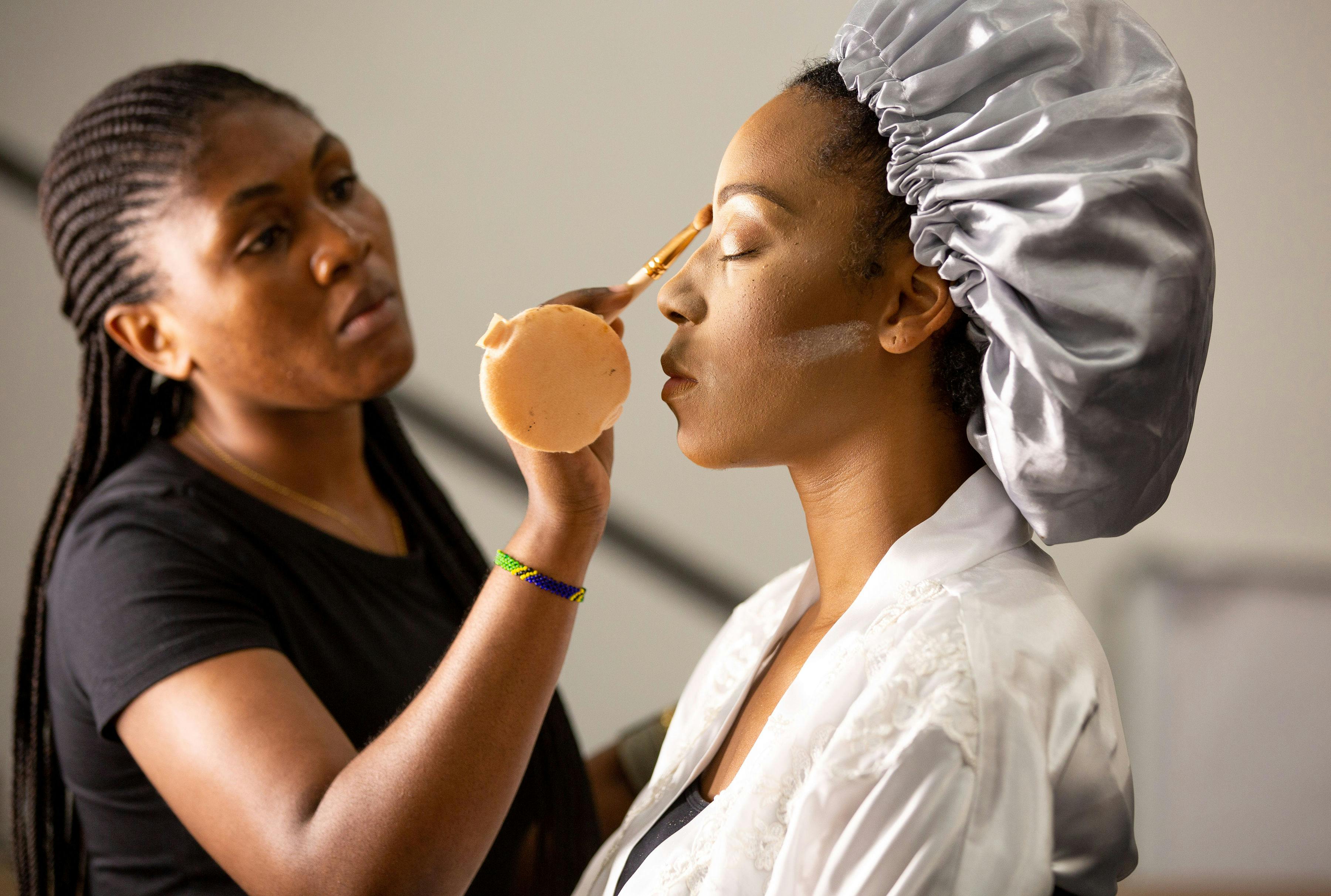 Makeup Artist Doing Makeup of a Woman · Free Stock Photo