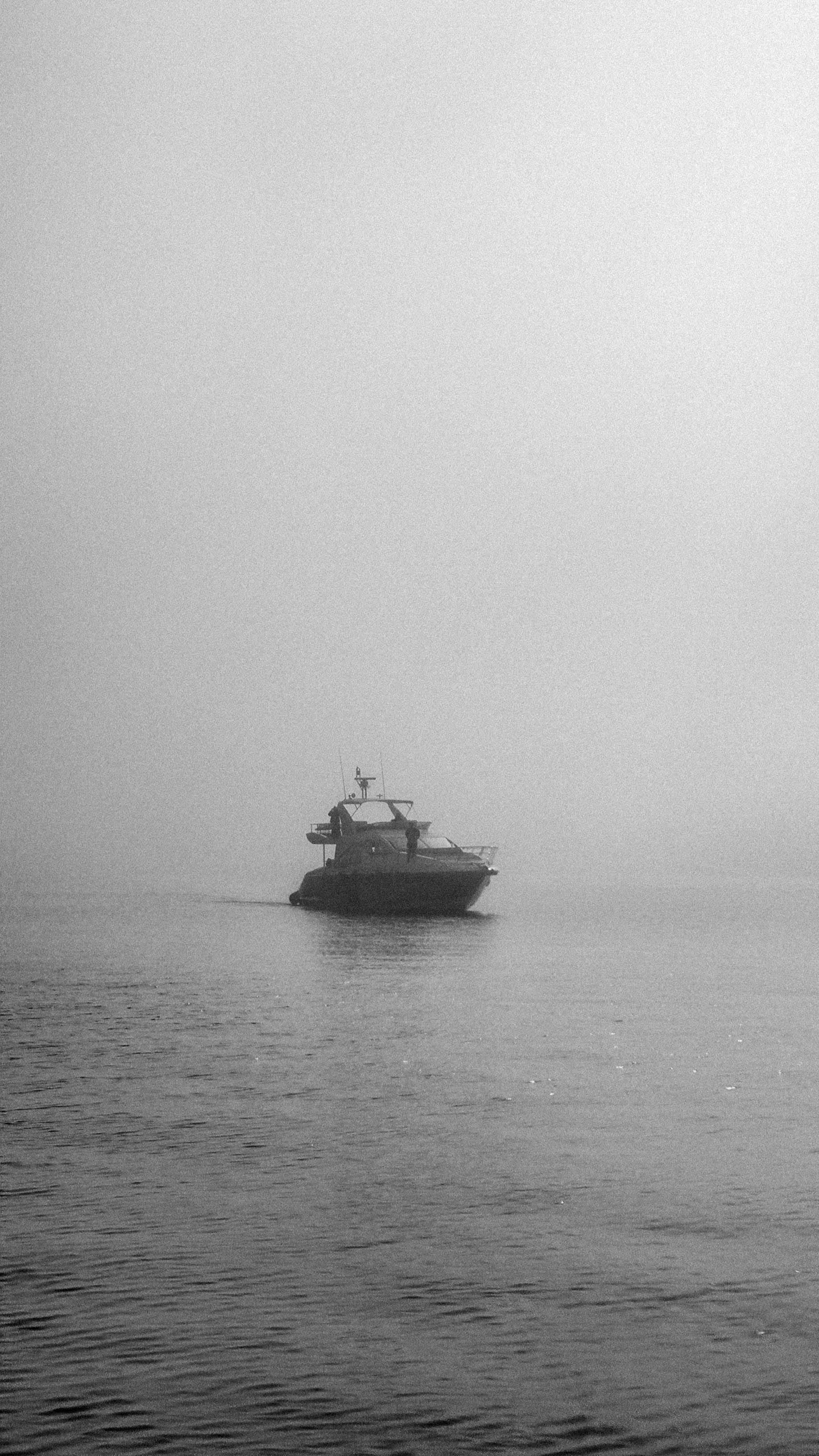 Grayscale Photography of a Boat on Body of Water · Free Stock Photo