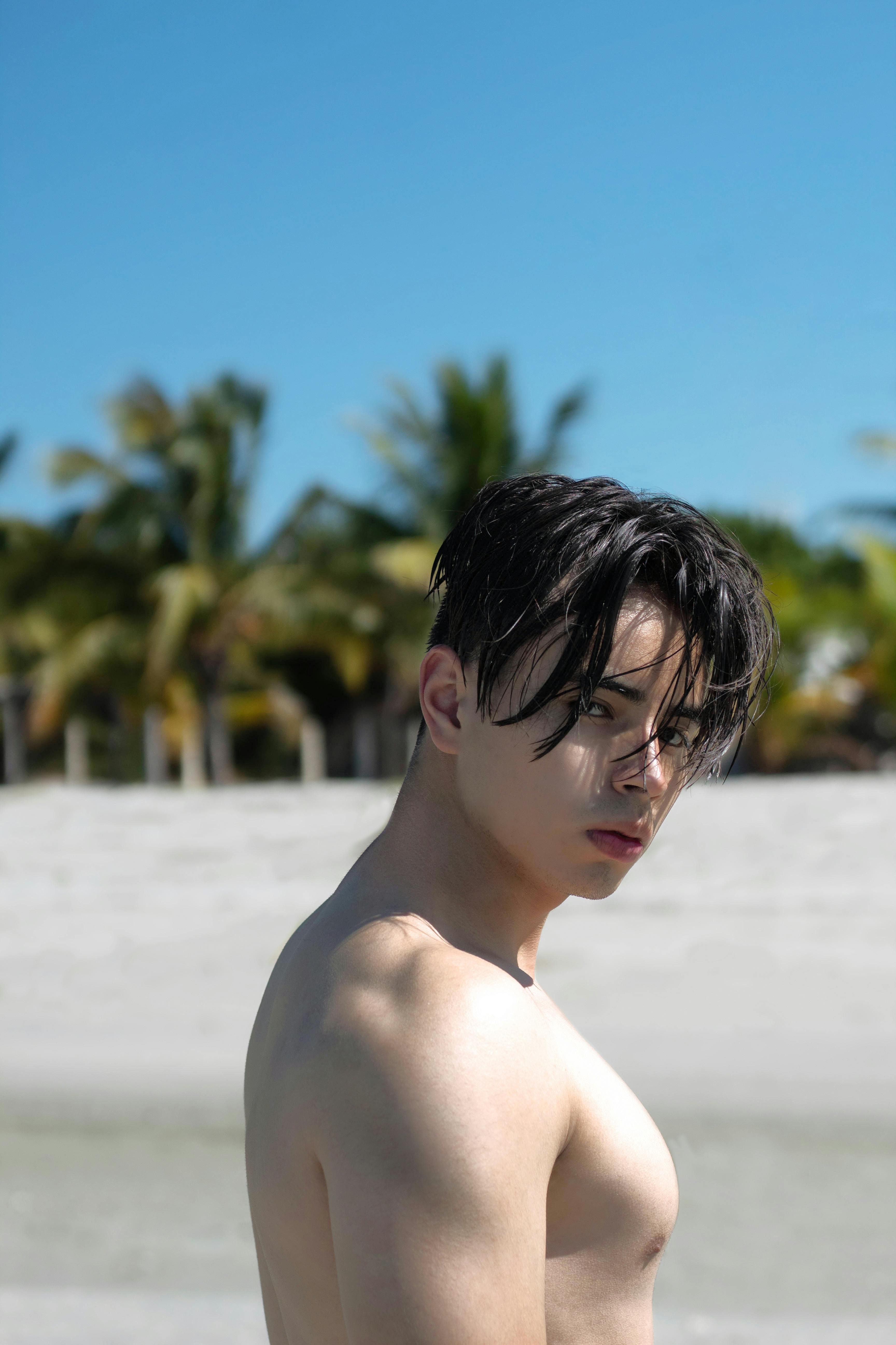 Photograph of a Shirtless Man at the Beach · Free Stock Photo
