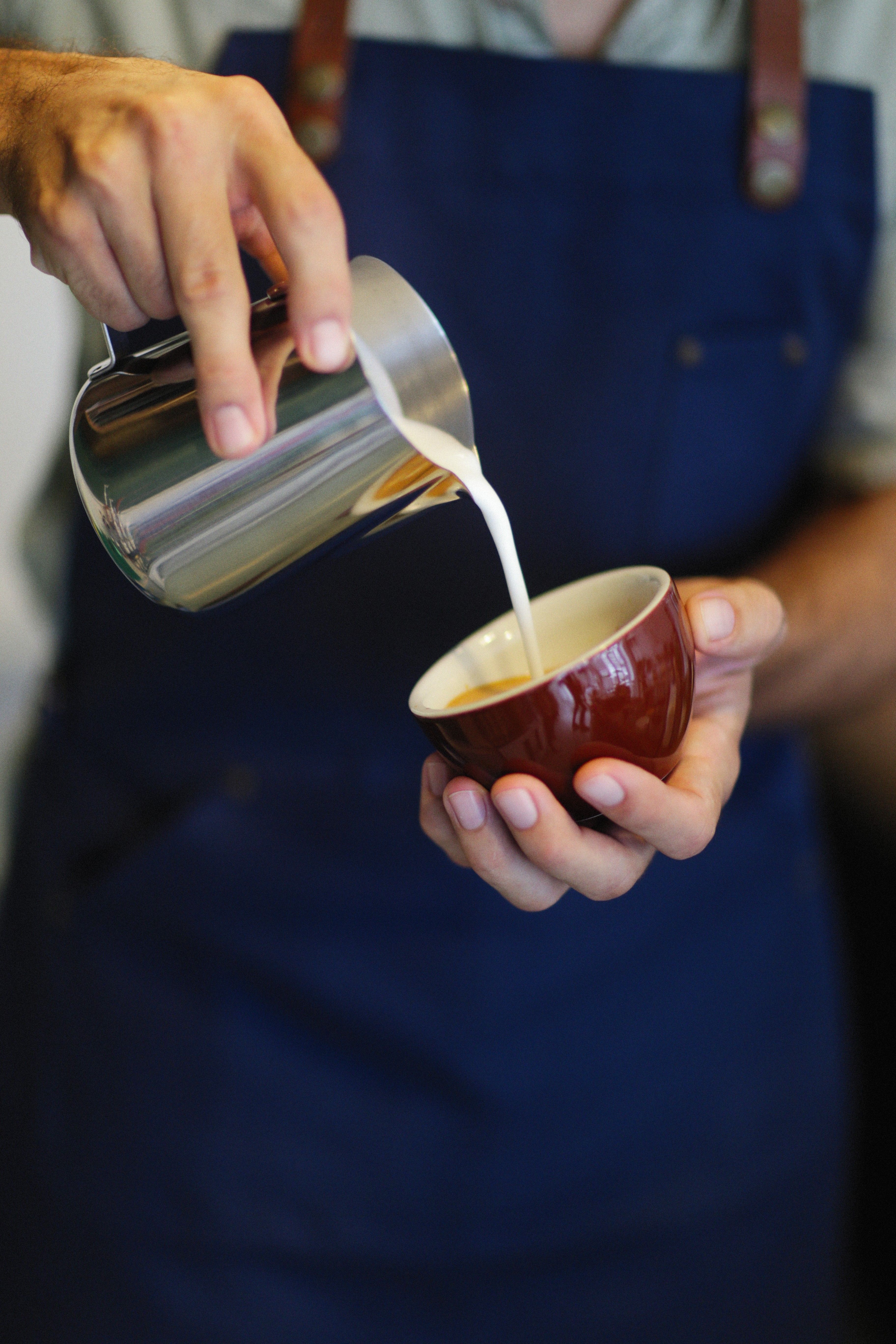 Person Pouring Black Ink in a Small Cup · Free Stock Photo