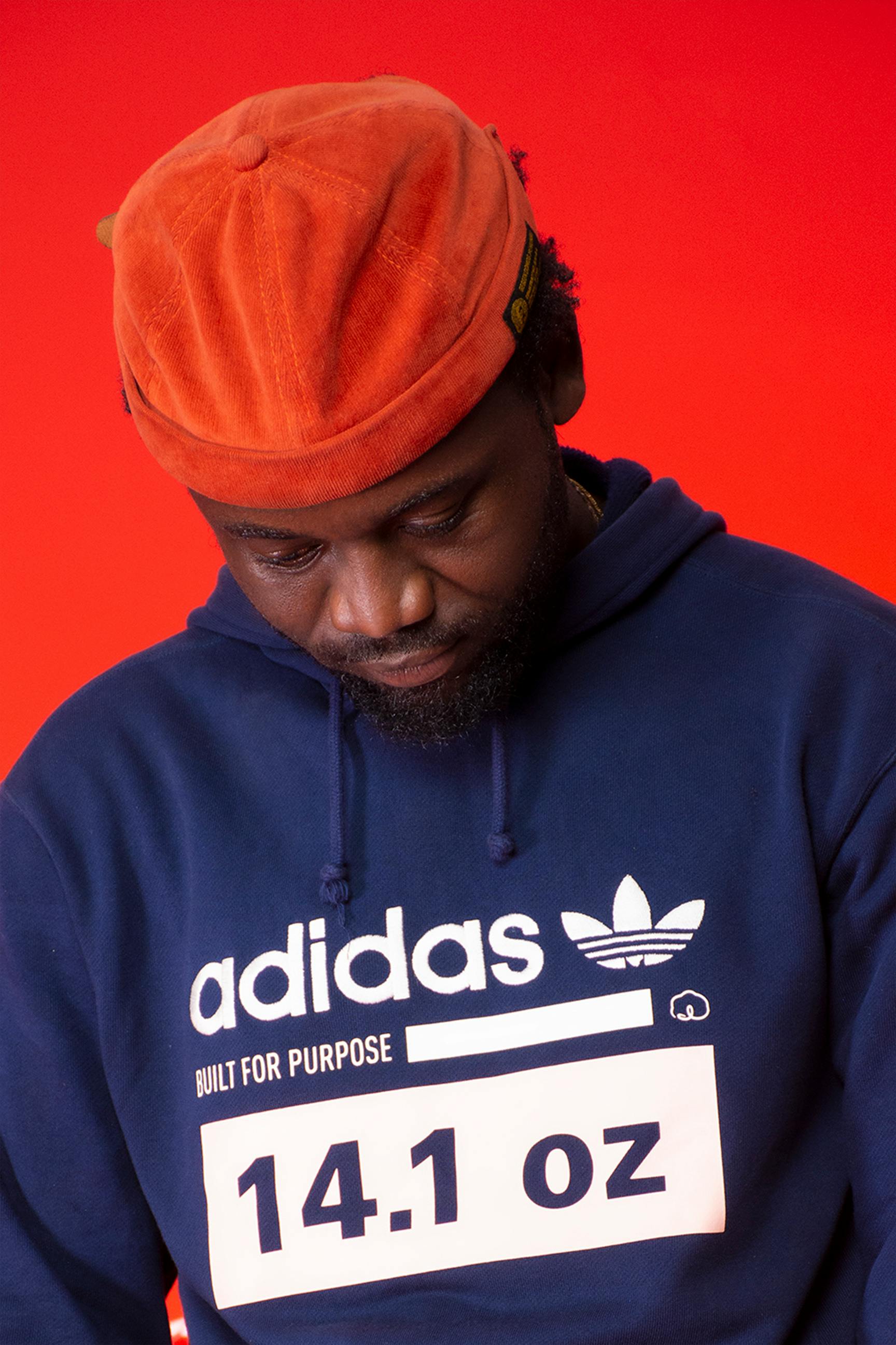 A Man Wearing a Red Cap and Blue Hoodie · Free Stock Photo