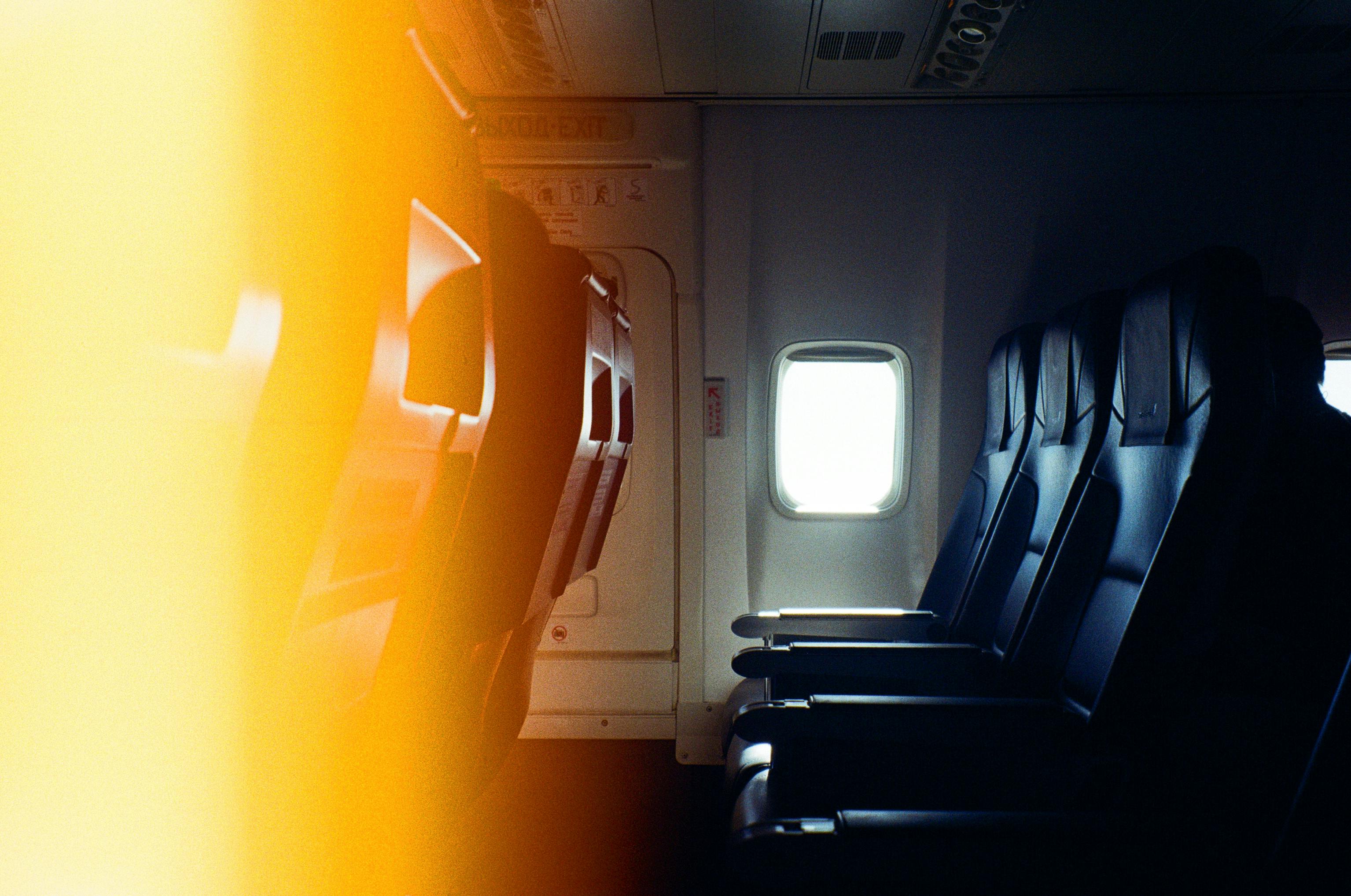 Black Seats Beside the Airplane Window · Free Stock Photo