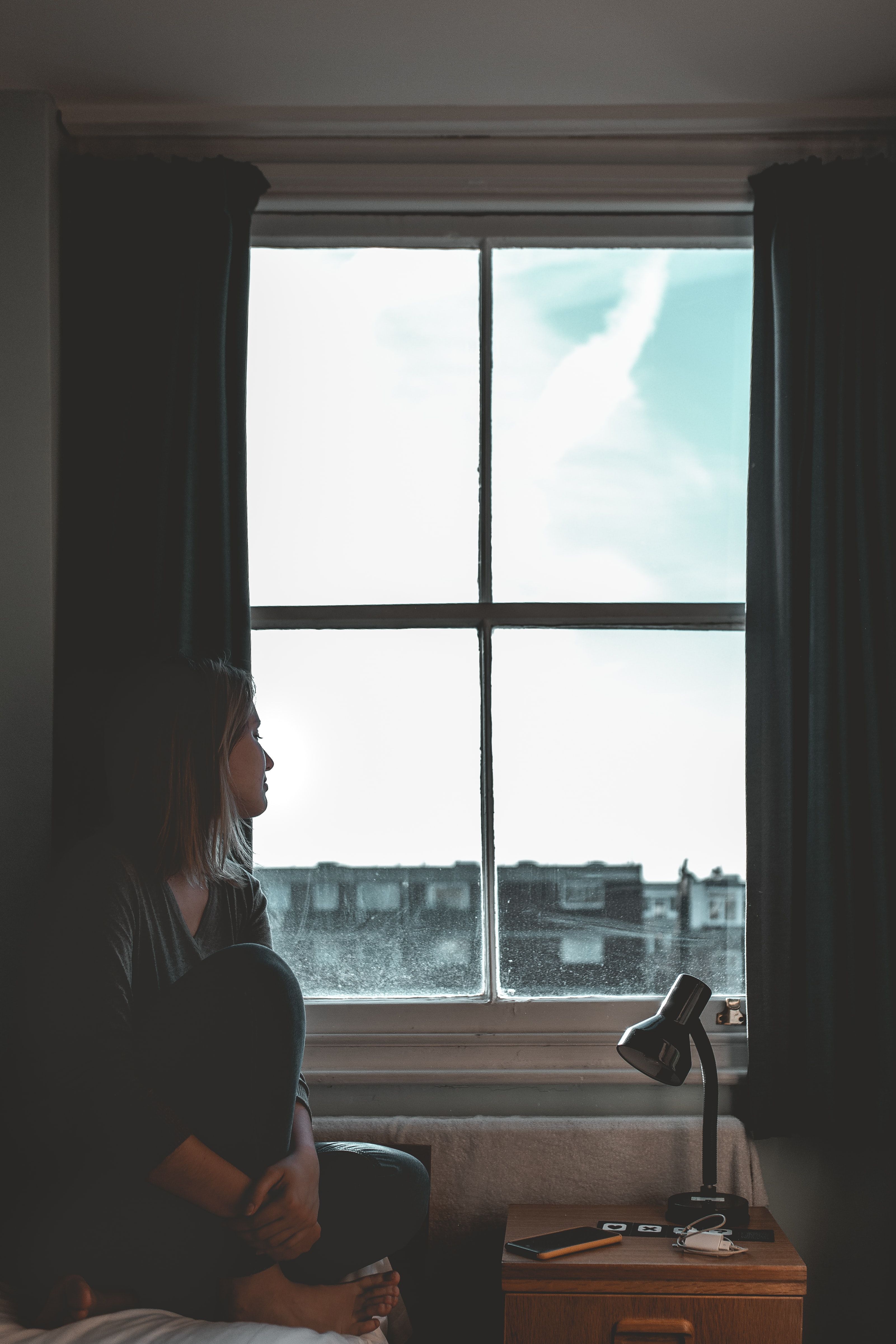 Woman Sitting near Window · Free Stock Photo