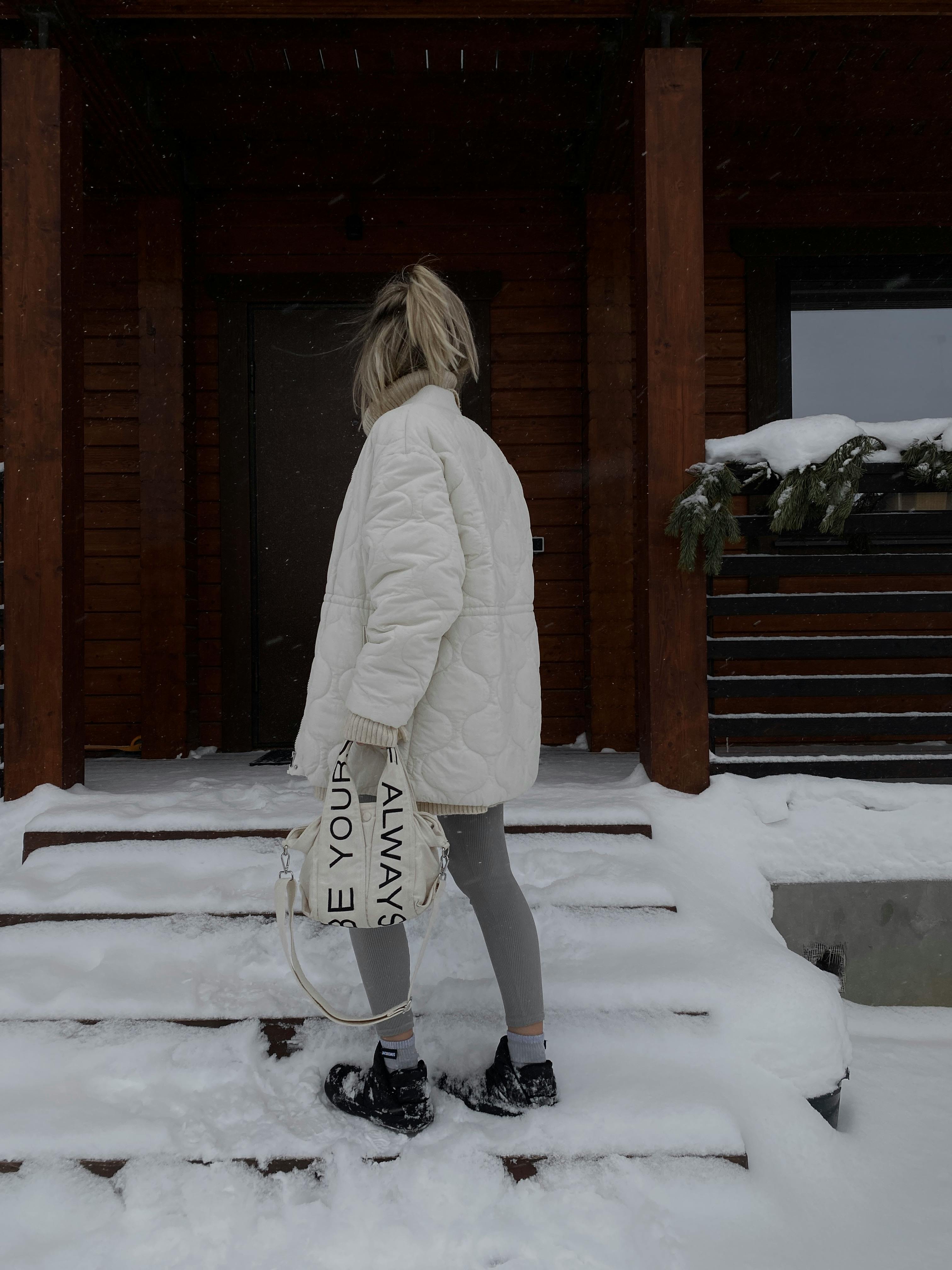 Back View of a Person Wearing a White Winter Jacket · Free Stock Photo