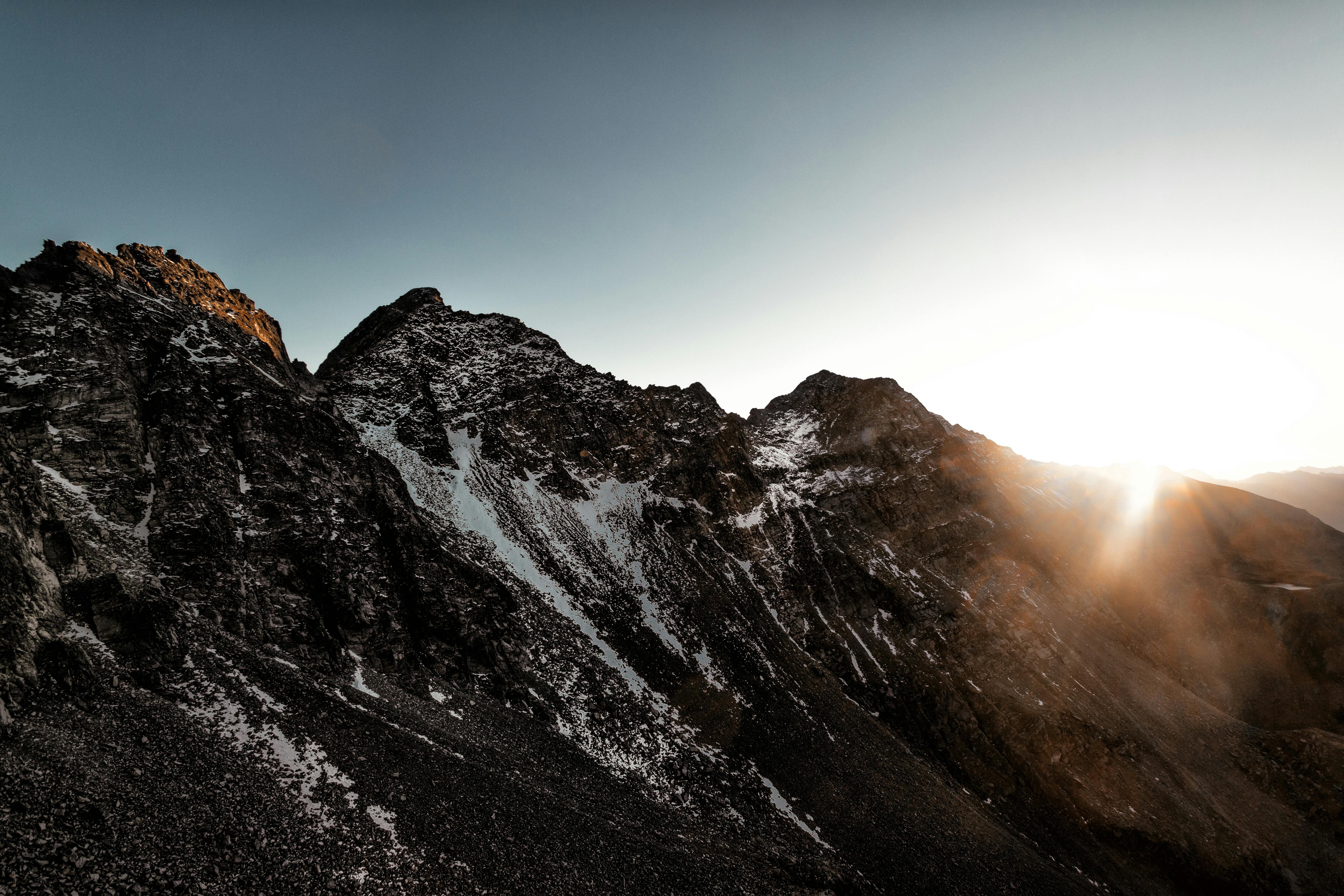 Gray Rock Mountain With White Snow during Sun Rise Aerial Photography ...
