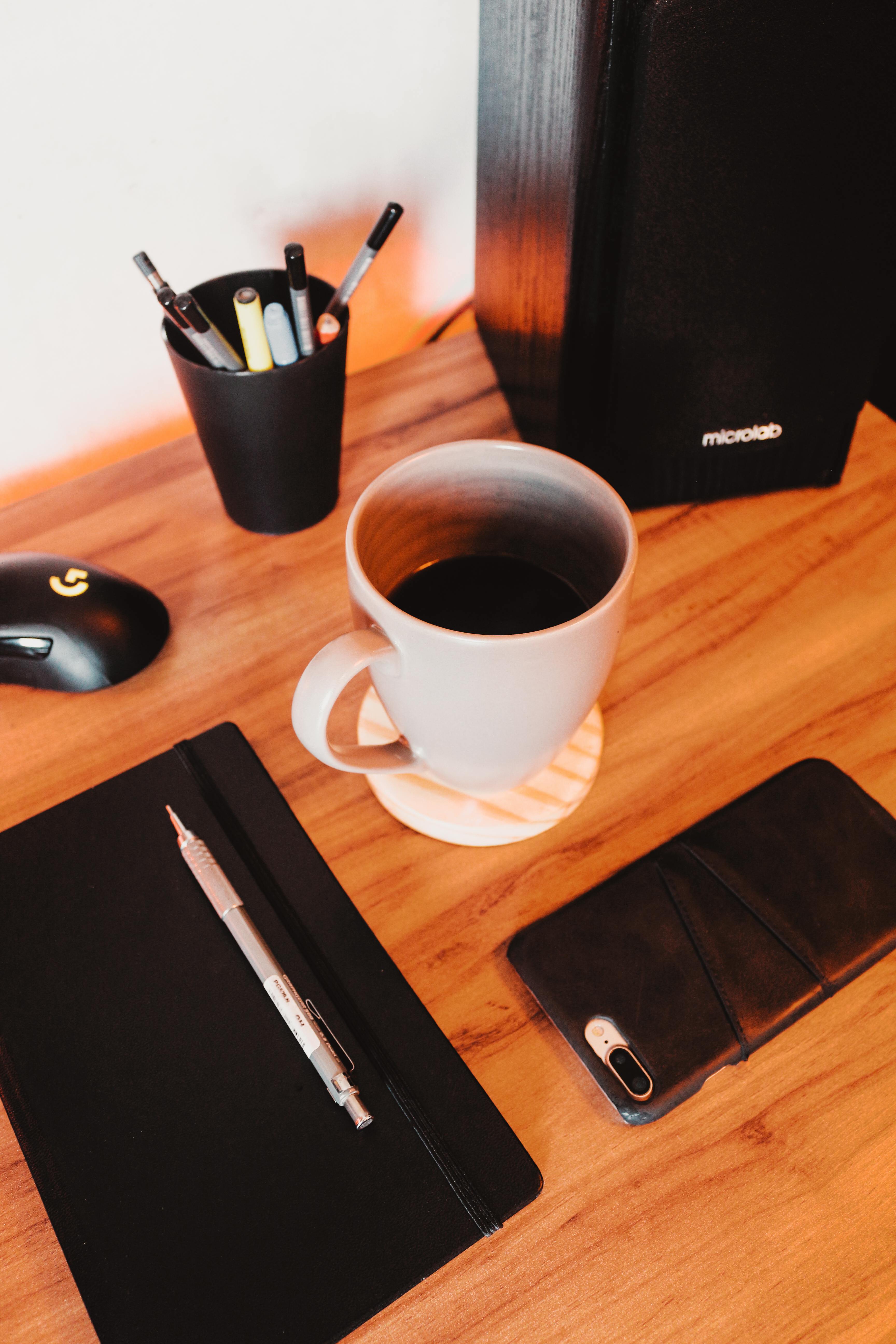 Pens in Cup on Stack of Books · Free Stock Photo