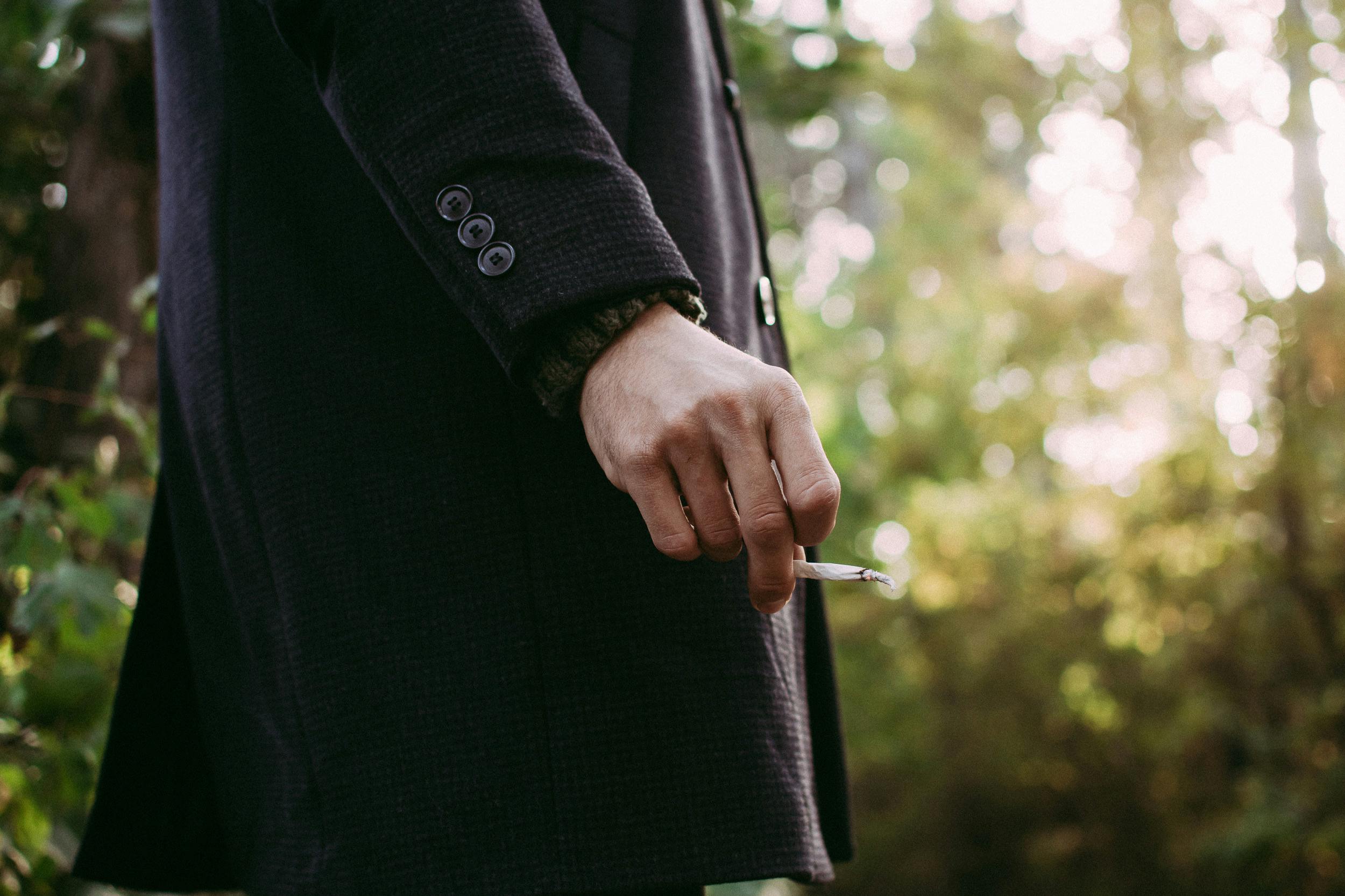 Hands in Robes Holding Sticks · Free Stock Photo