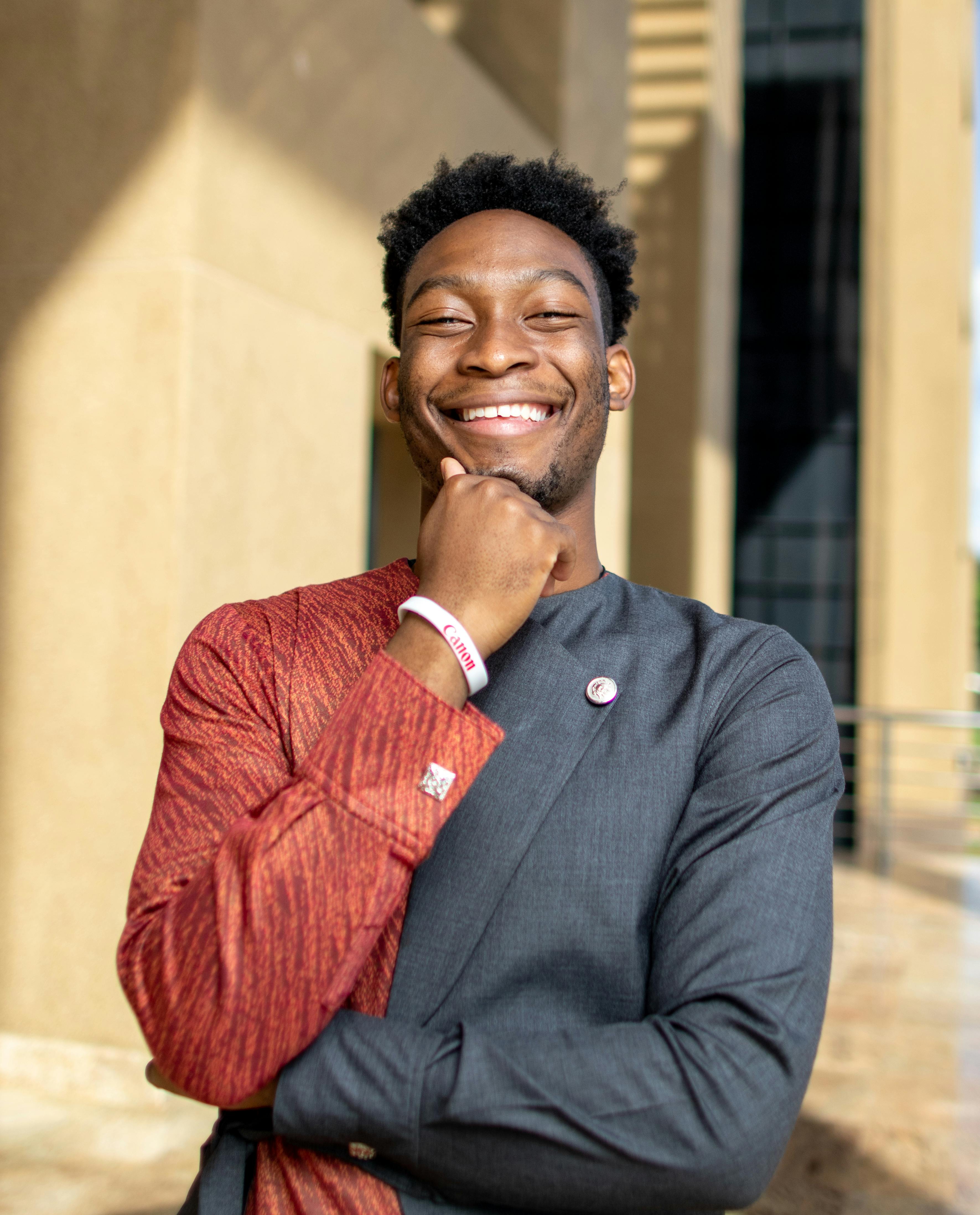 A Man Touching his Chin While Smiling · Free Stock Photo