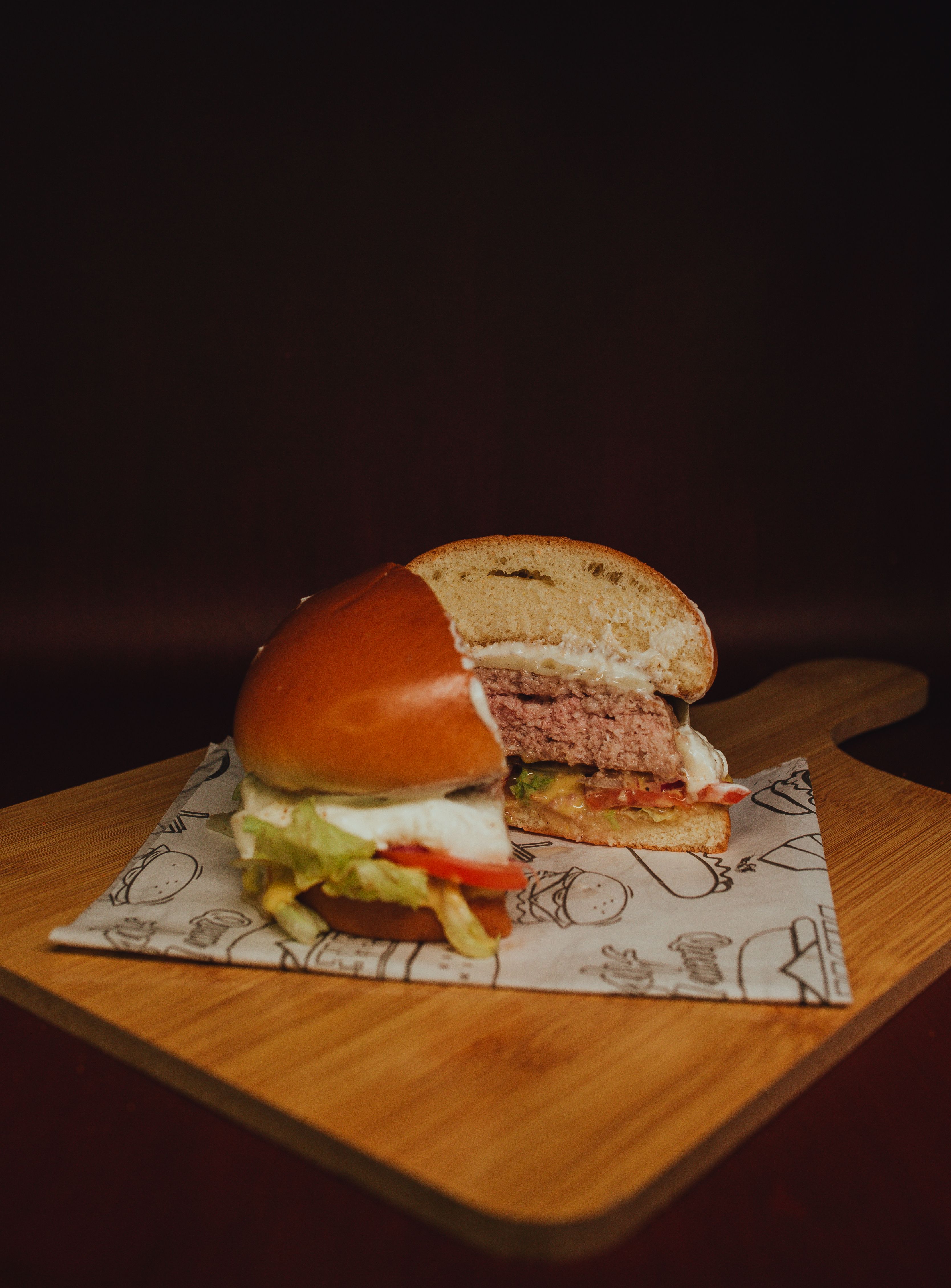 Sliced Burger on a Serving Board · Free Stock Photo