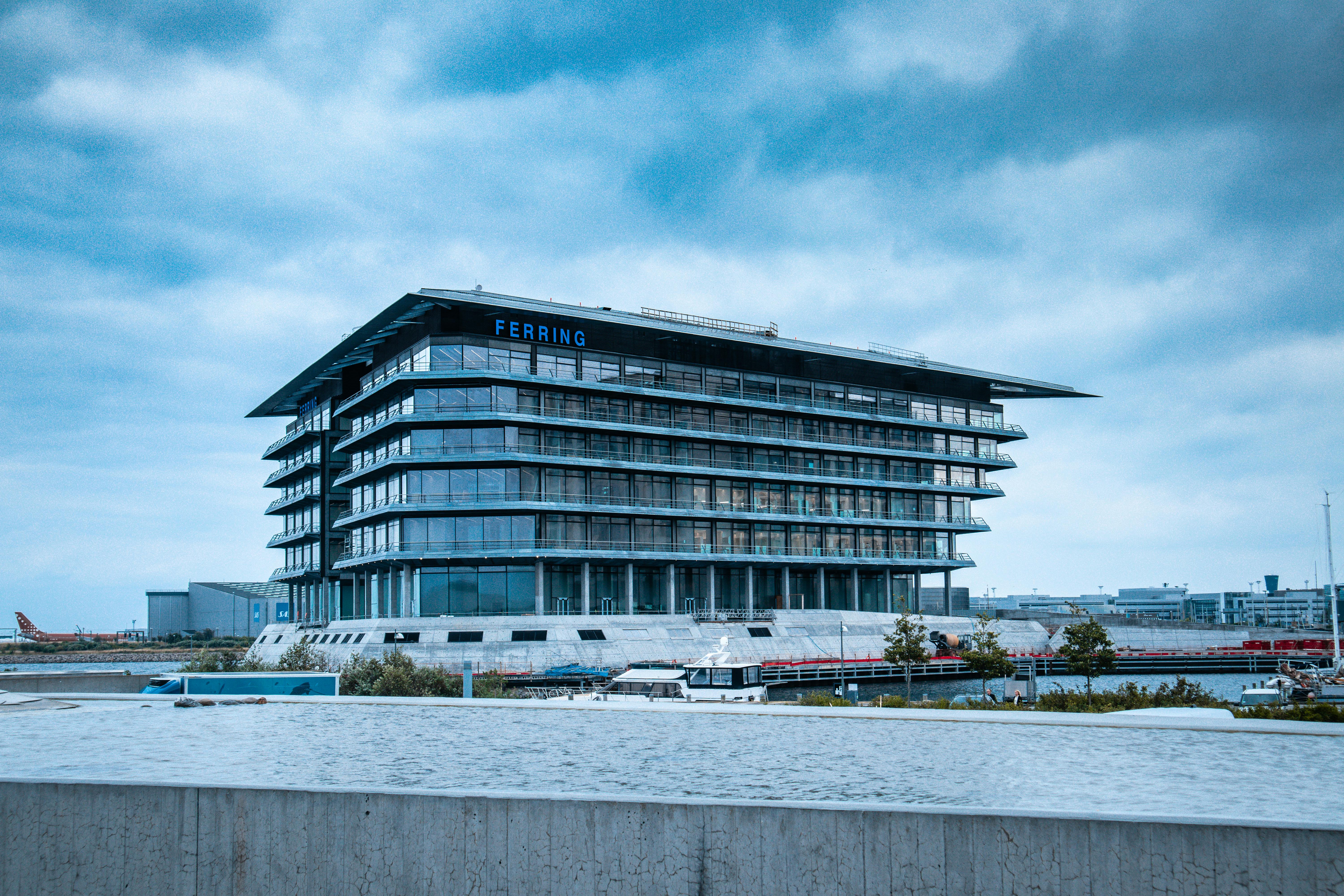 Glass Building under the Cloudy Sky · Free Stock Photo