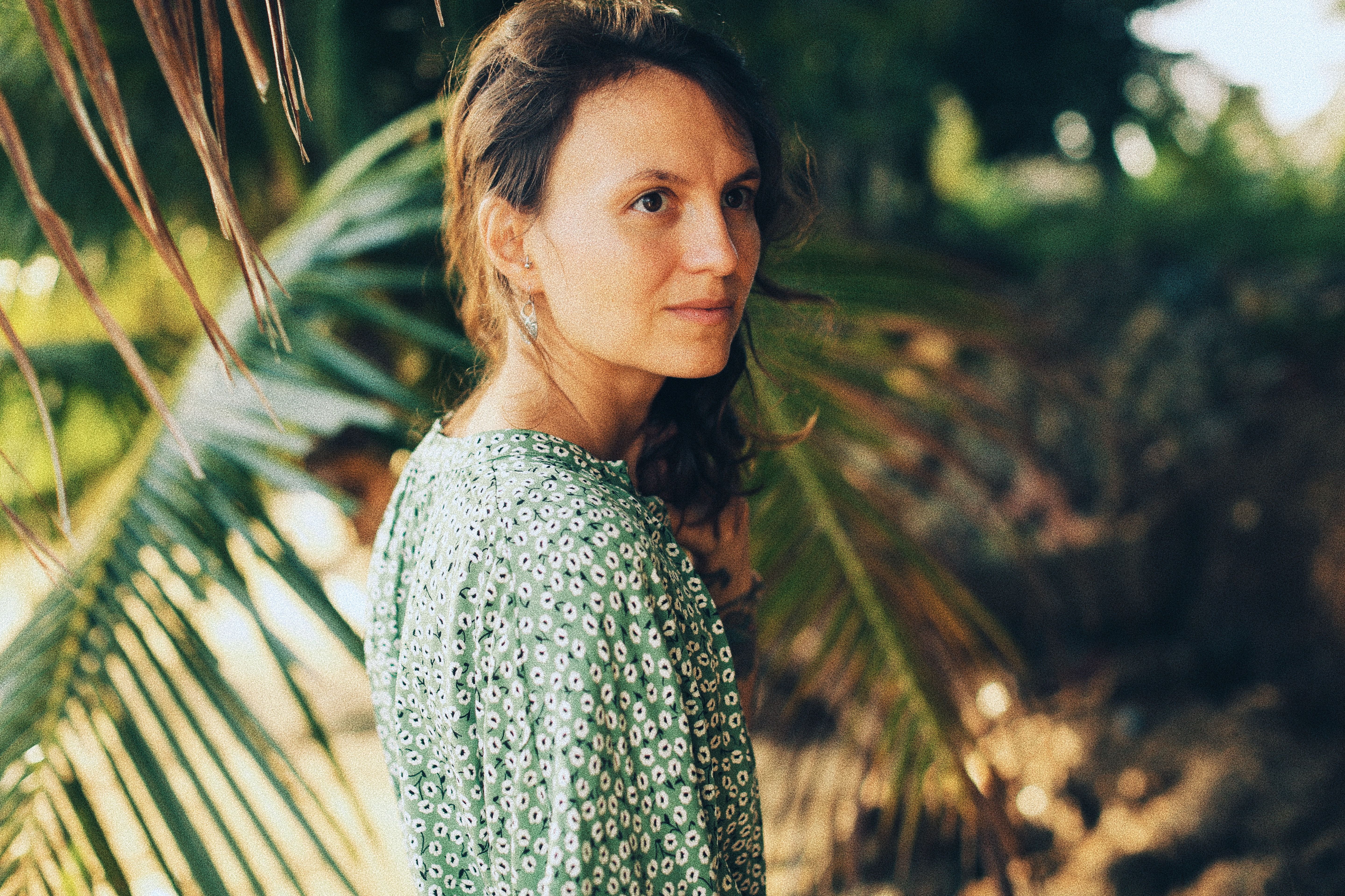 Beautiful Woman in Green Dress Standing Beside the Leaves · Free Stock ...