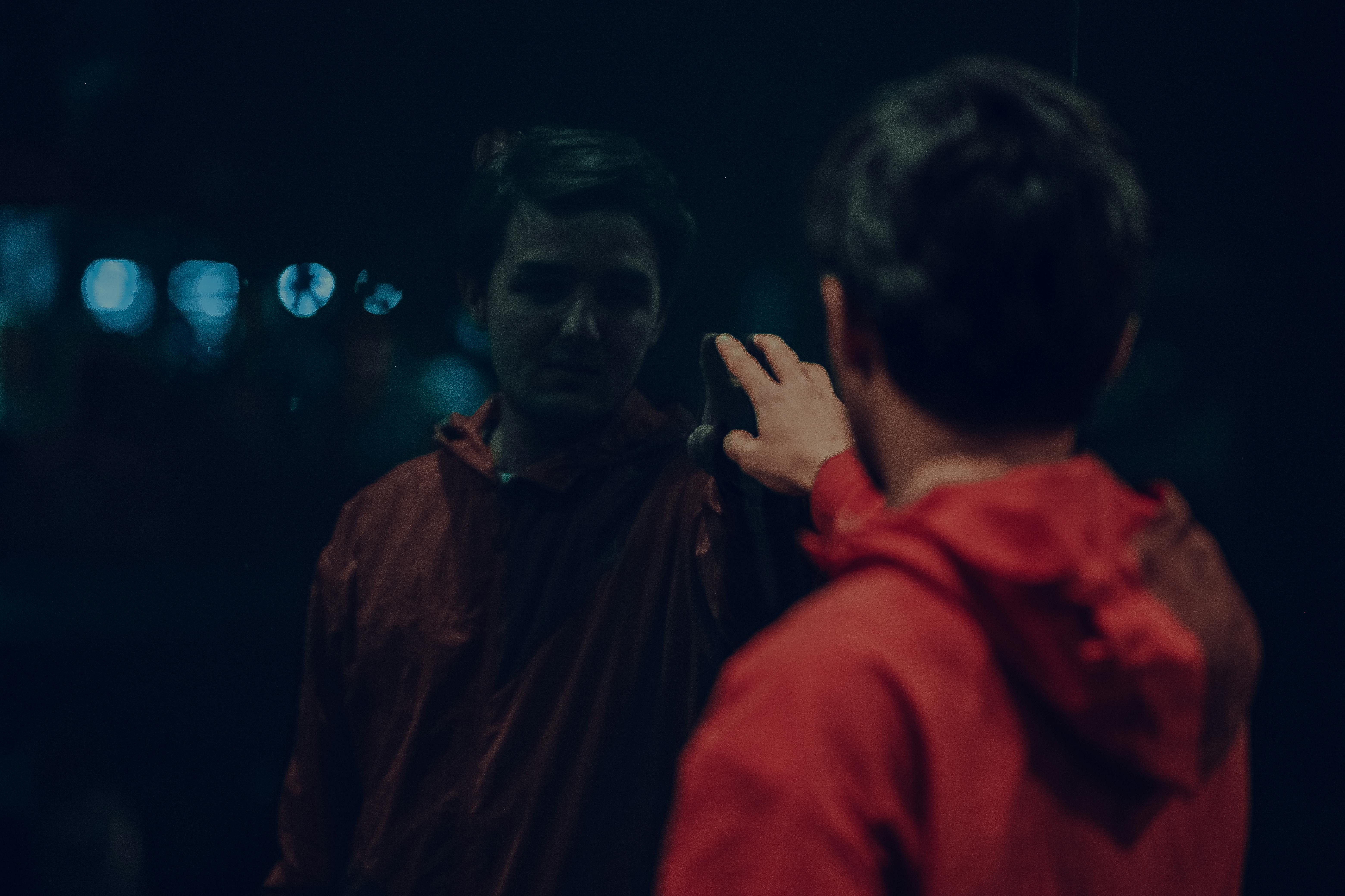 Man Touching Reflection in Mirror · Free Stock Photo