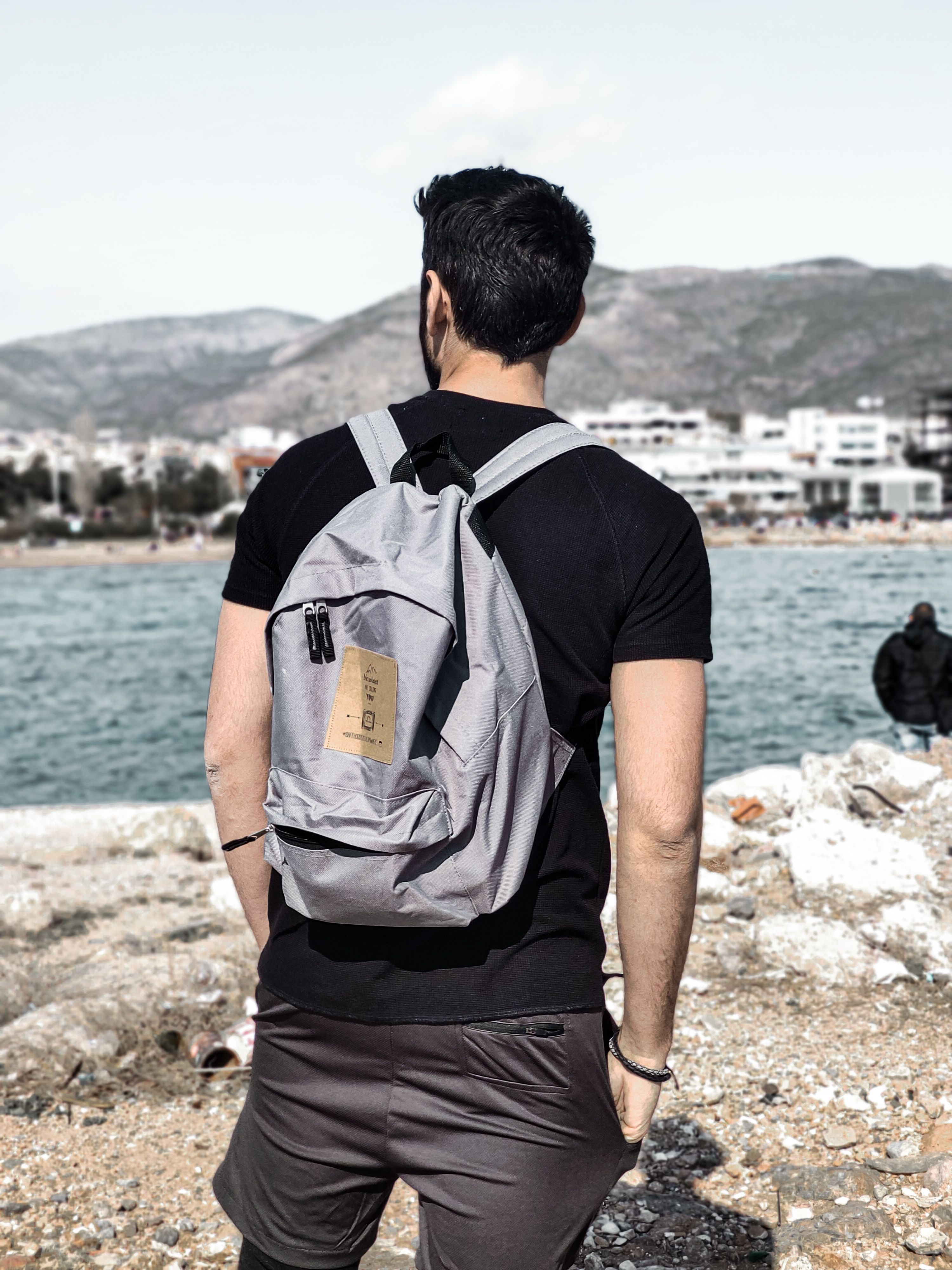 Back View of a Man Carrying His Backpack in Front of the Mountain ...