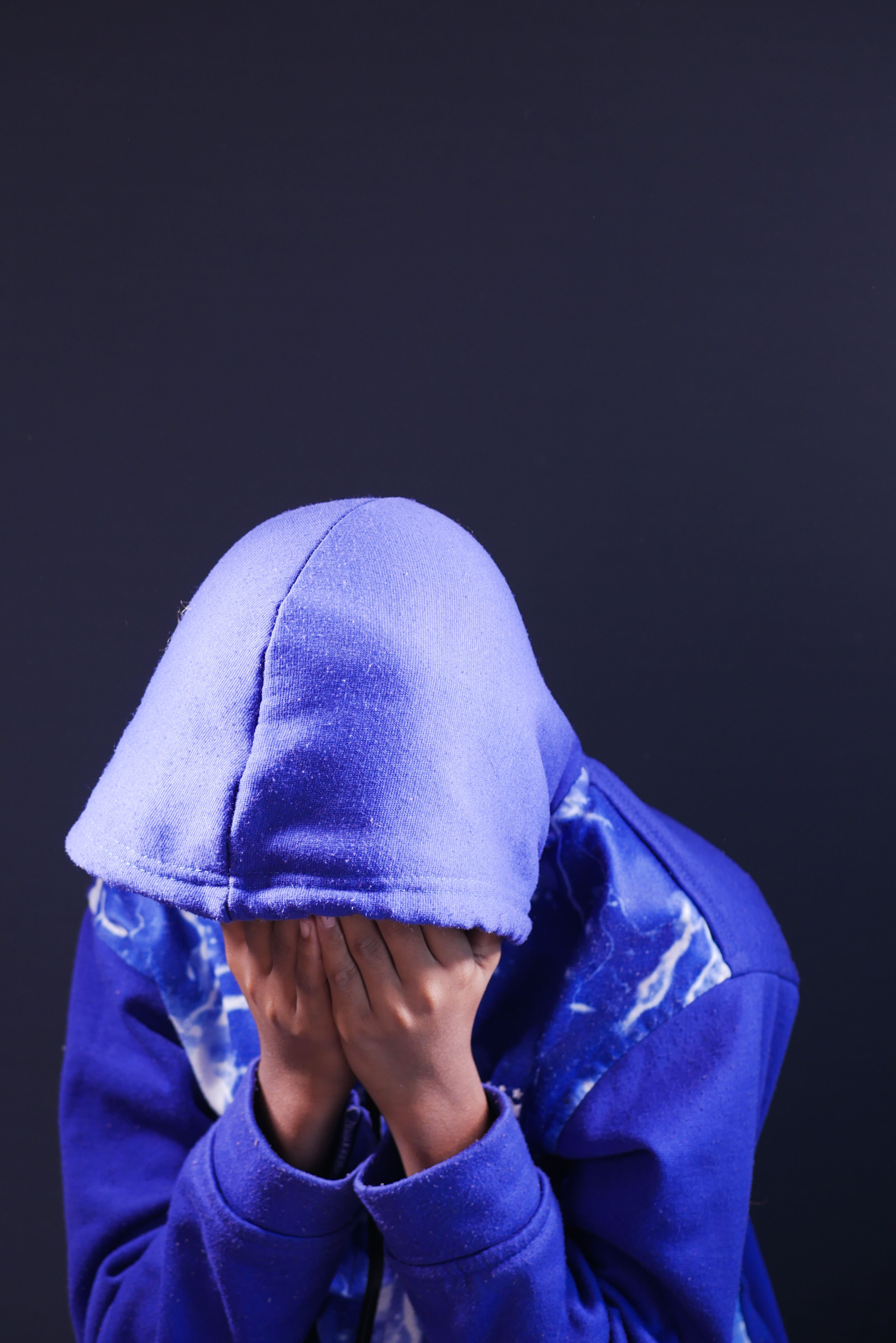 A Person in Yellow Hoodie Doing Hand Sign · Free Stock Photo