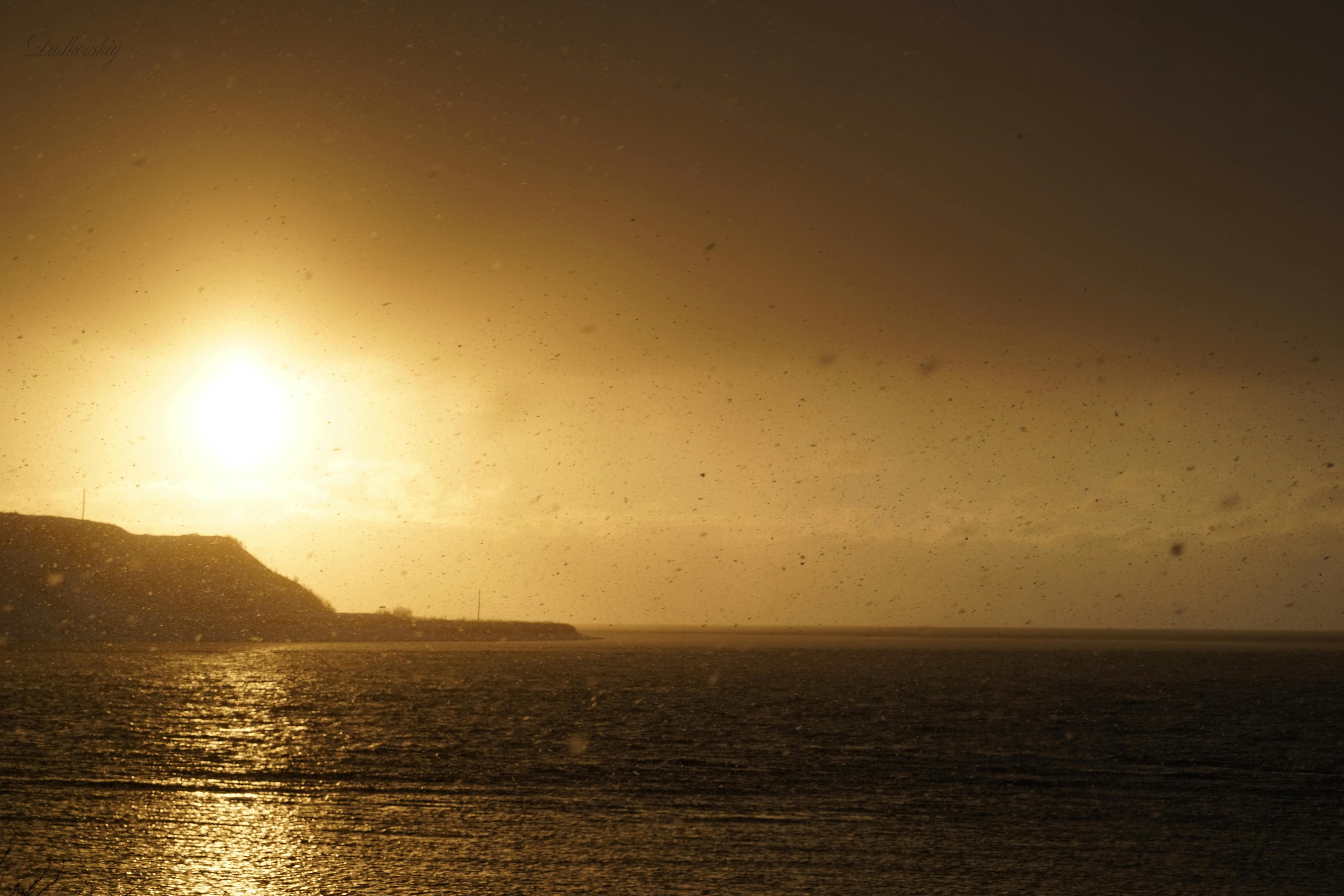 A Hand on the Water During Sunset · Free Stock Photo
