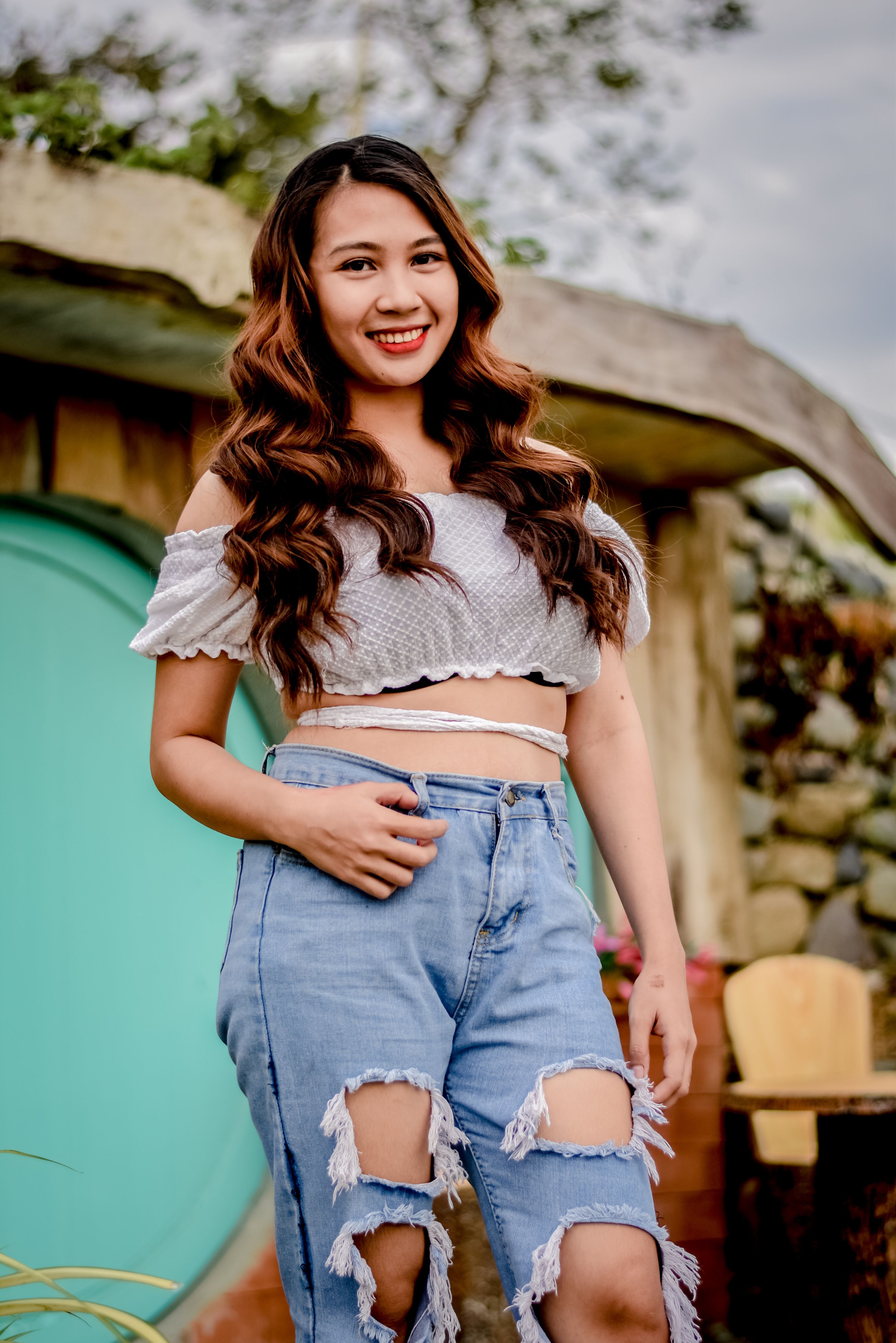 Woman in White Crop Top and Ripped Jeans Smiling · Free Stock Photo