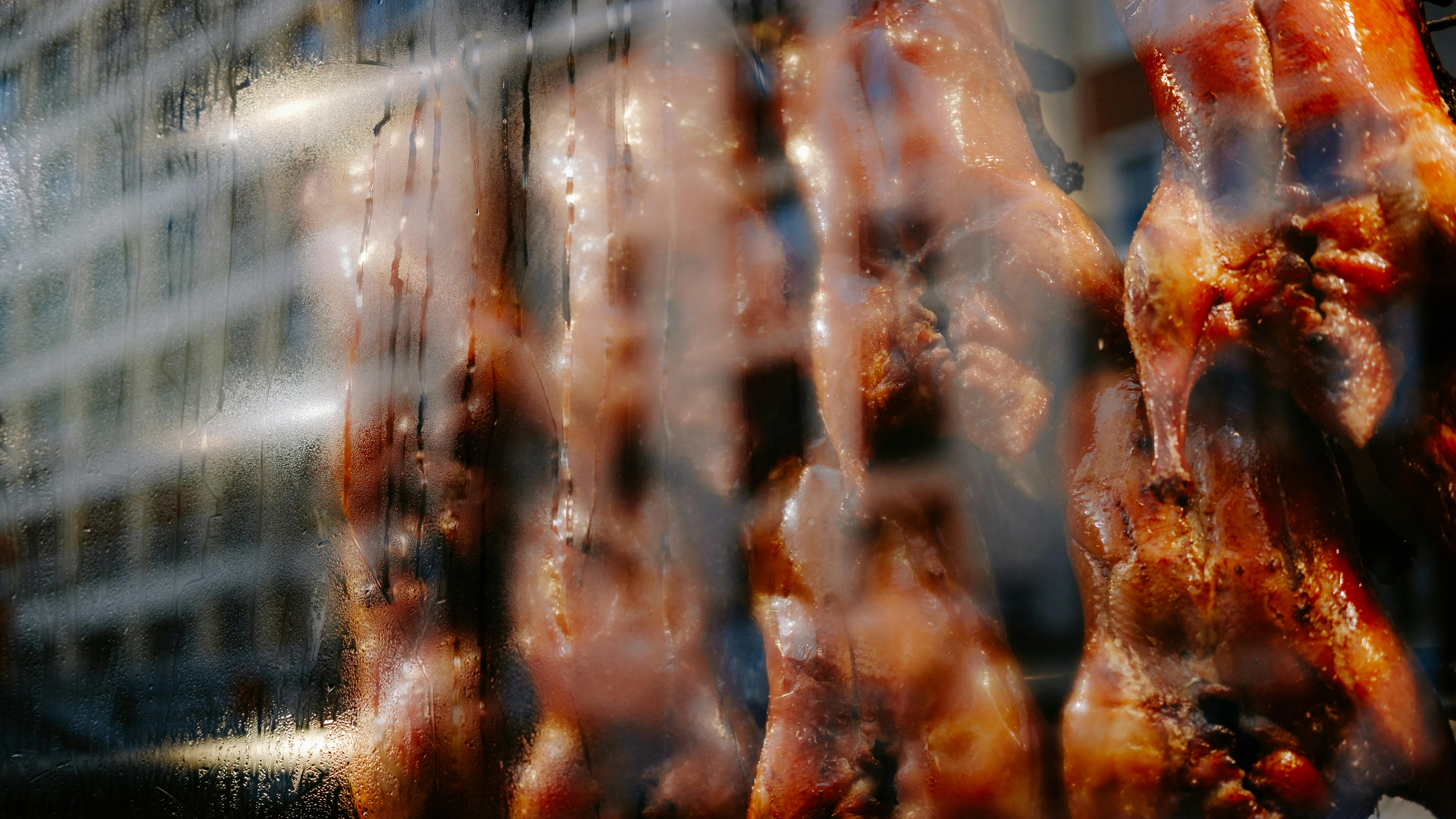 Meat behind Butcher Store Window · Free Stock Photo