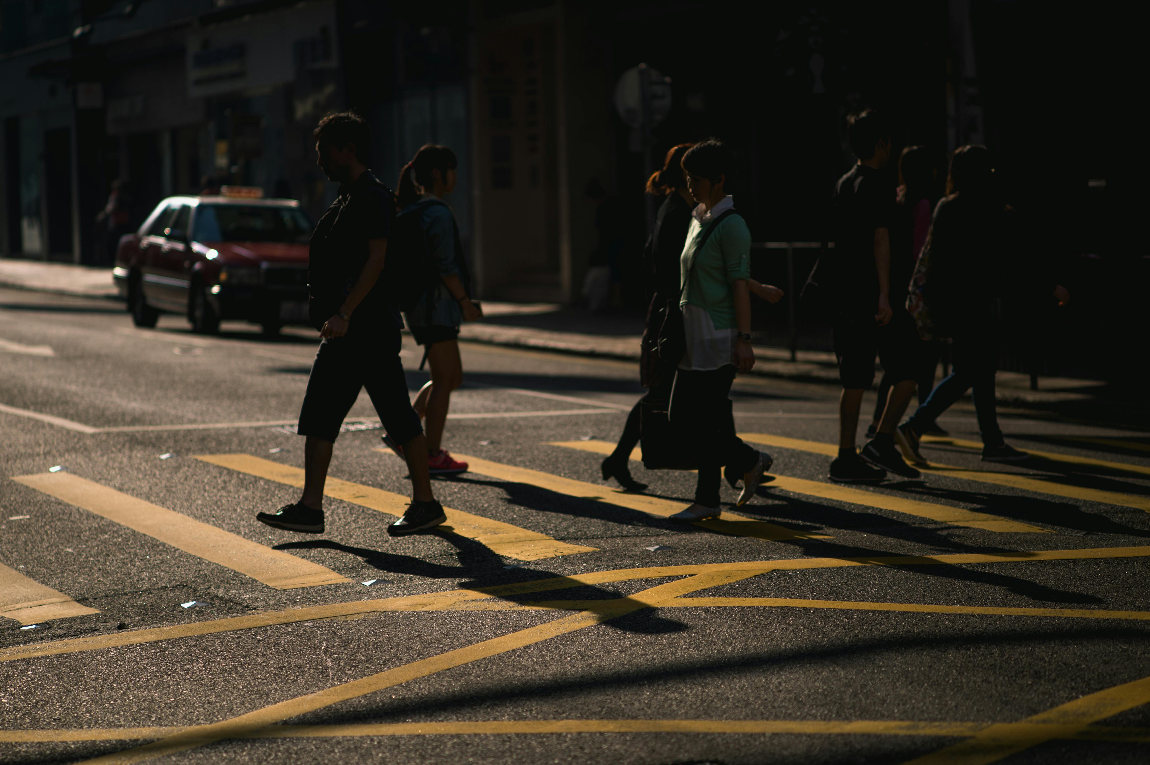 Photo Of Person Walking On Pedestrian Lane · Free Stock Photo
