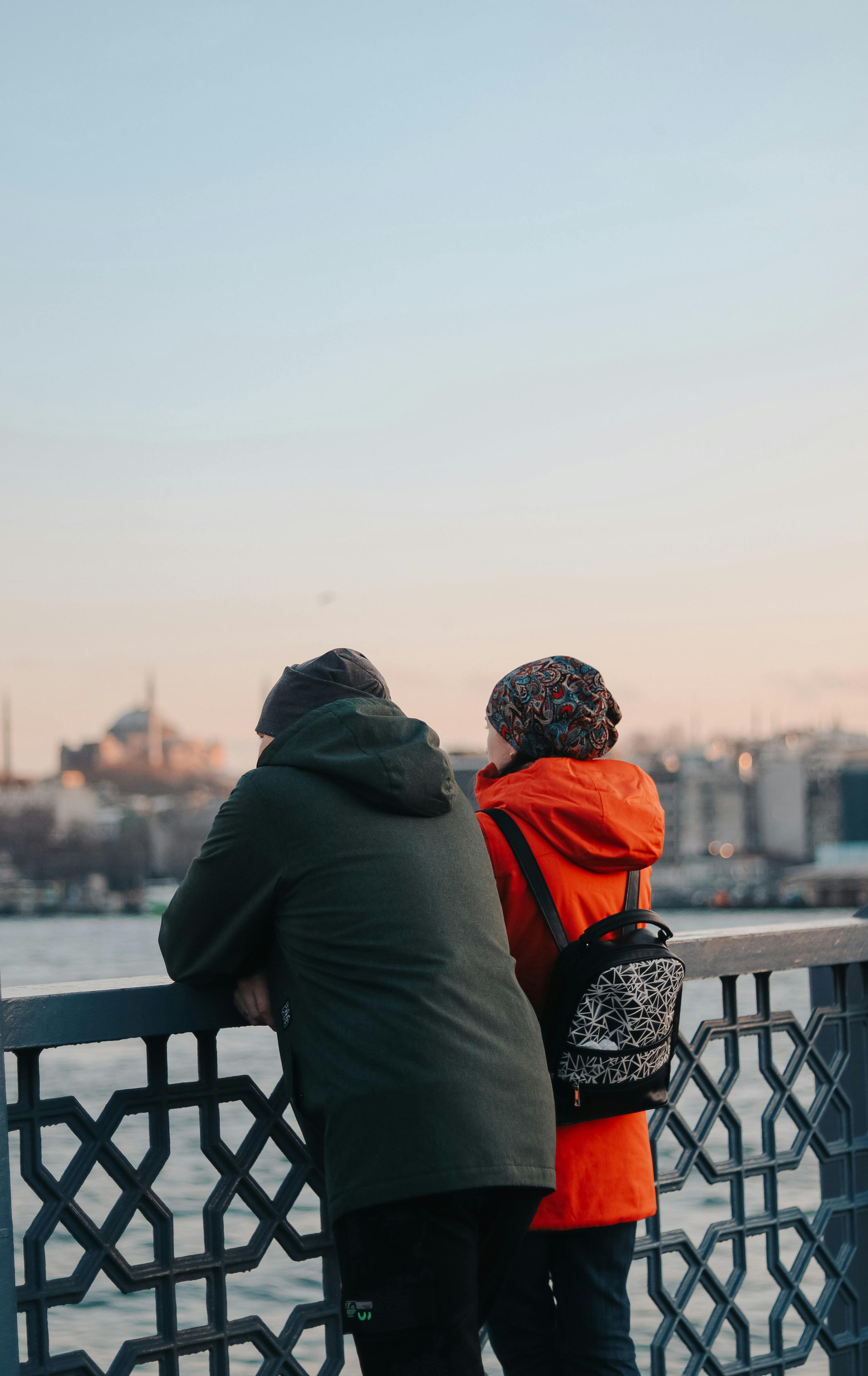 Man and Woman Leaning on Railing · Free Stock Photo