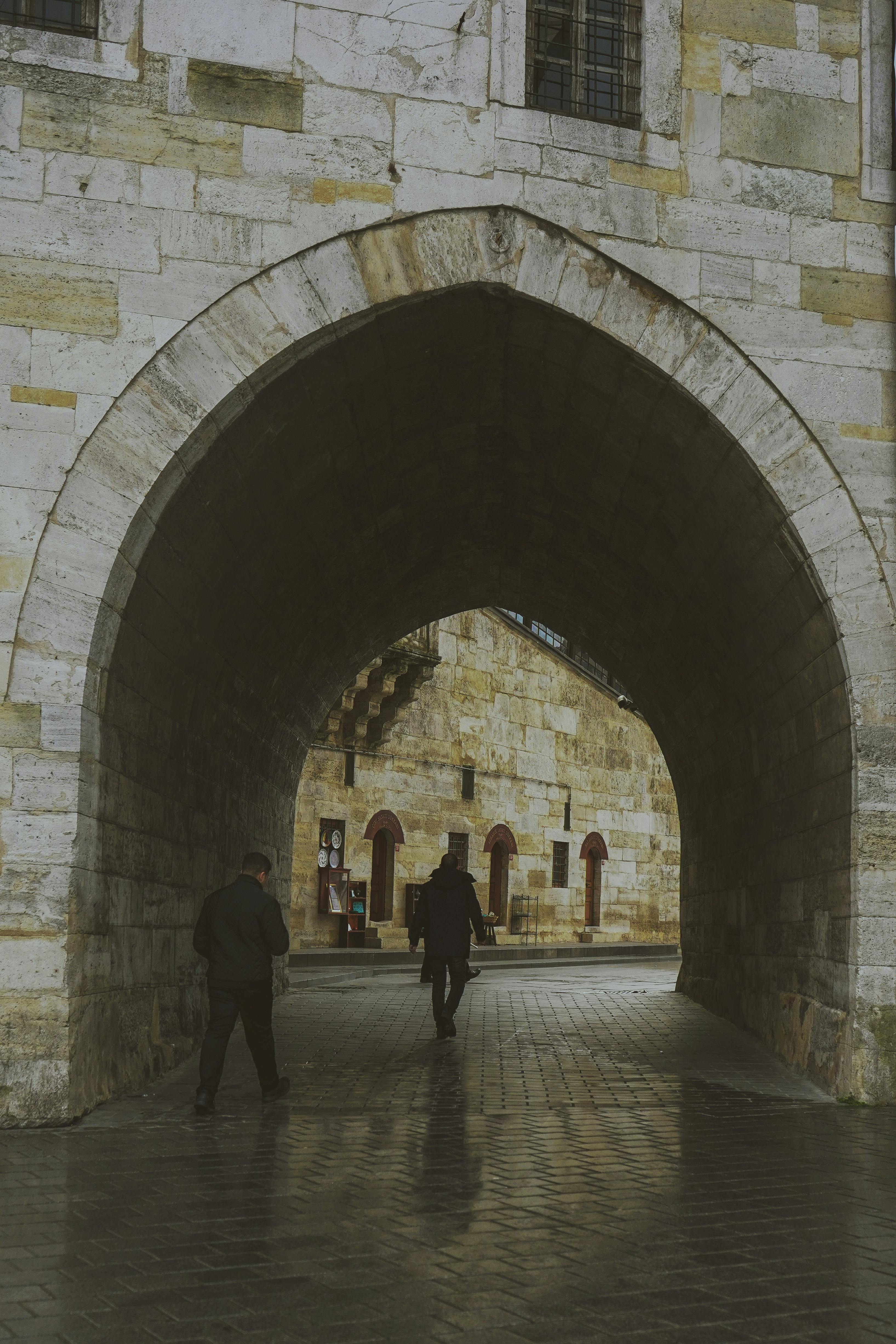 People Walking through Gate in Town · Free Stock Photo