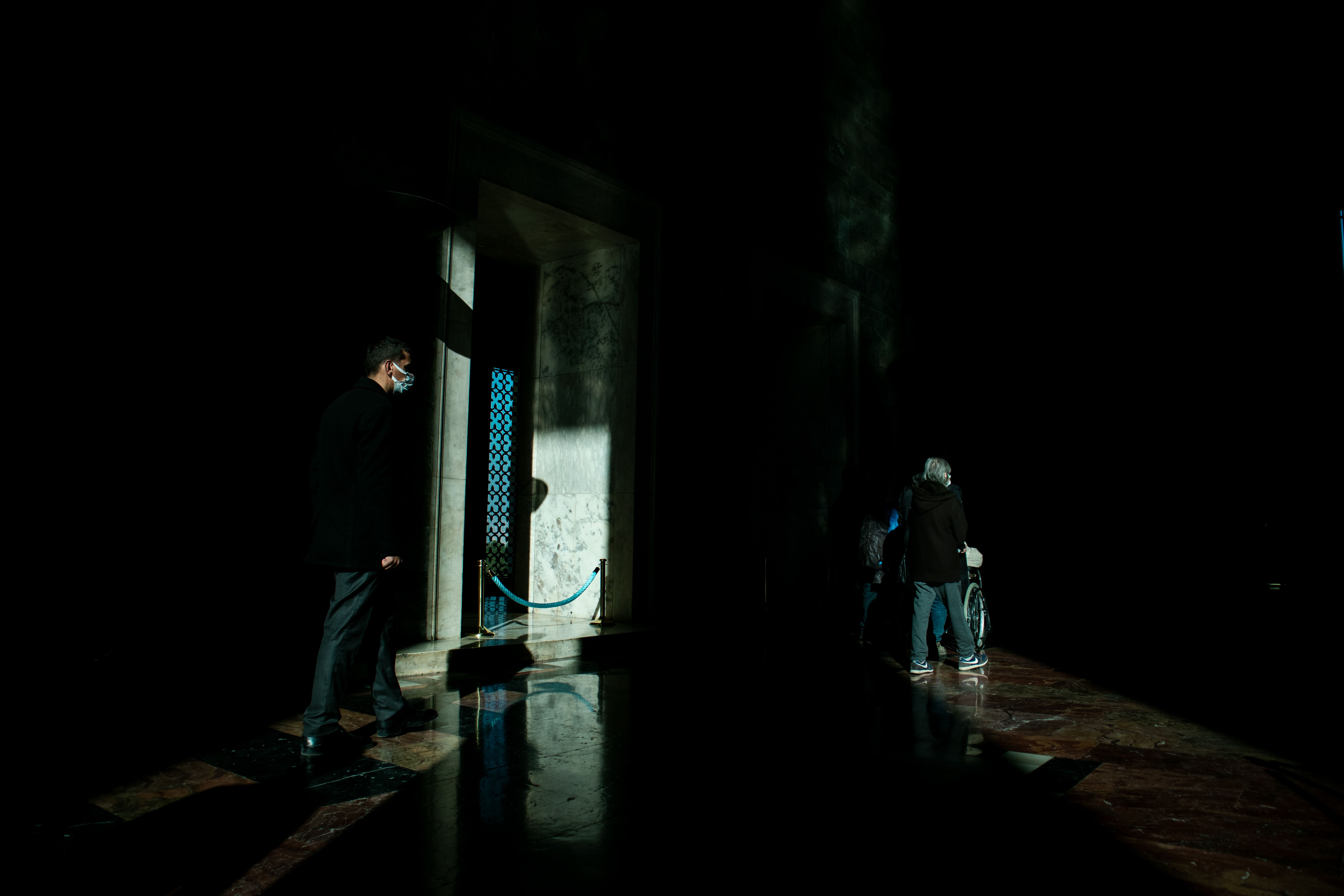 People in Shadowed Corridor of Museum · Free Stock Photo