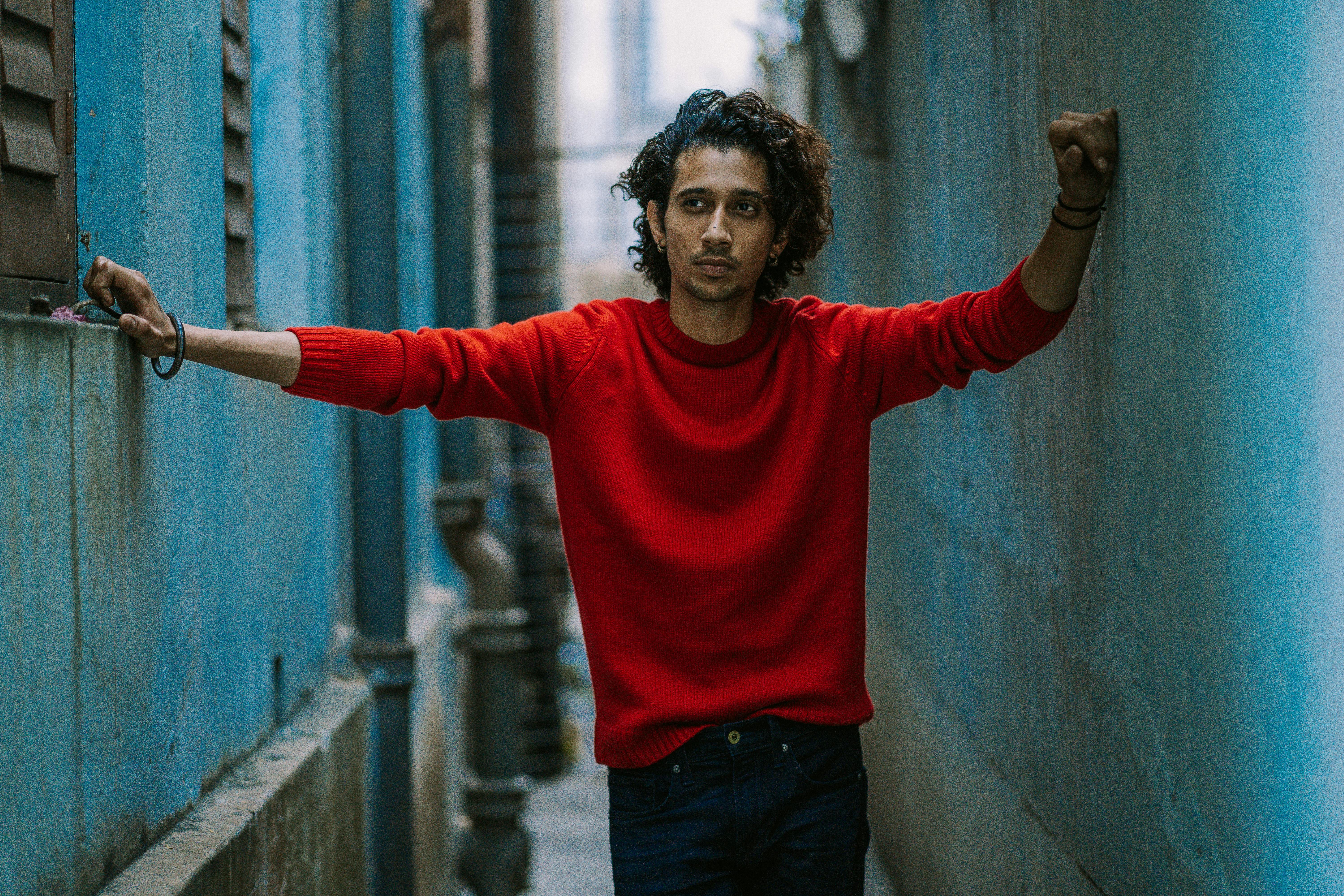 Person in Red Sweater while Posing · Free Stock Photo