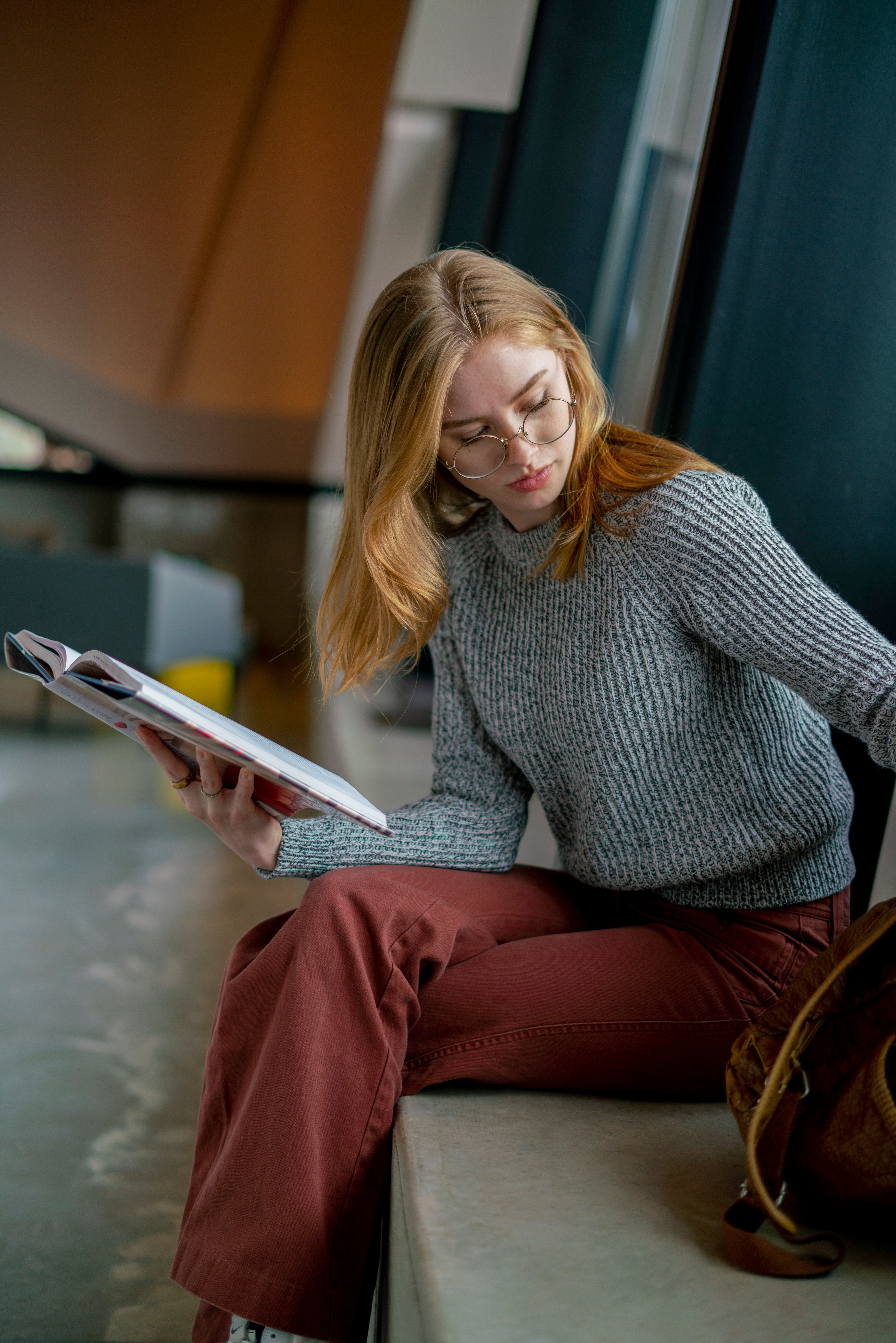 Woman in Gray Sweater Sitting on a Bench · Free Stock Photo