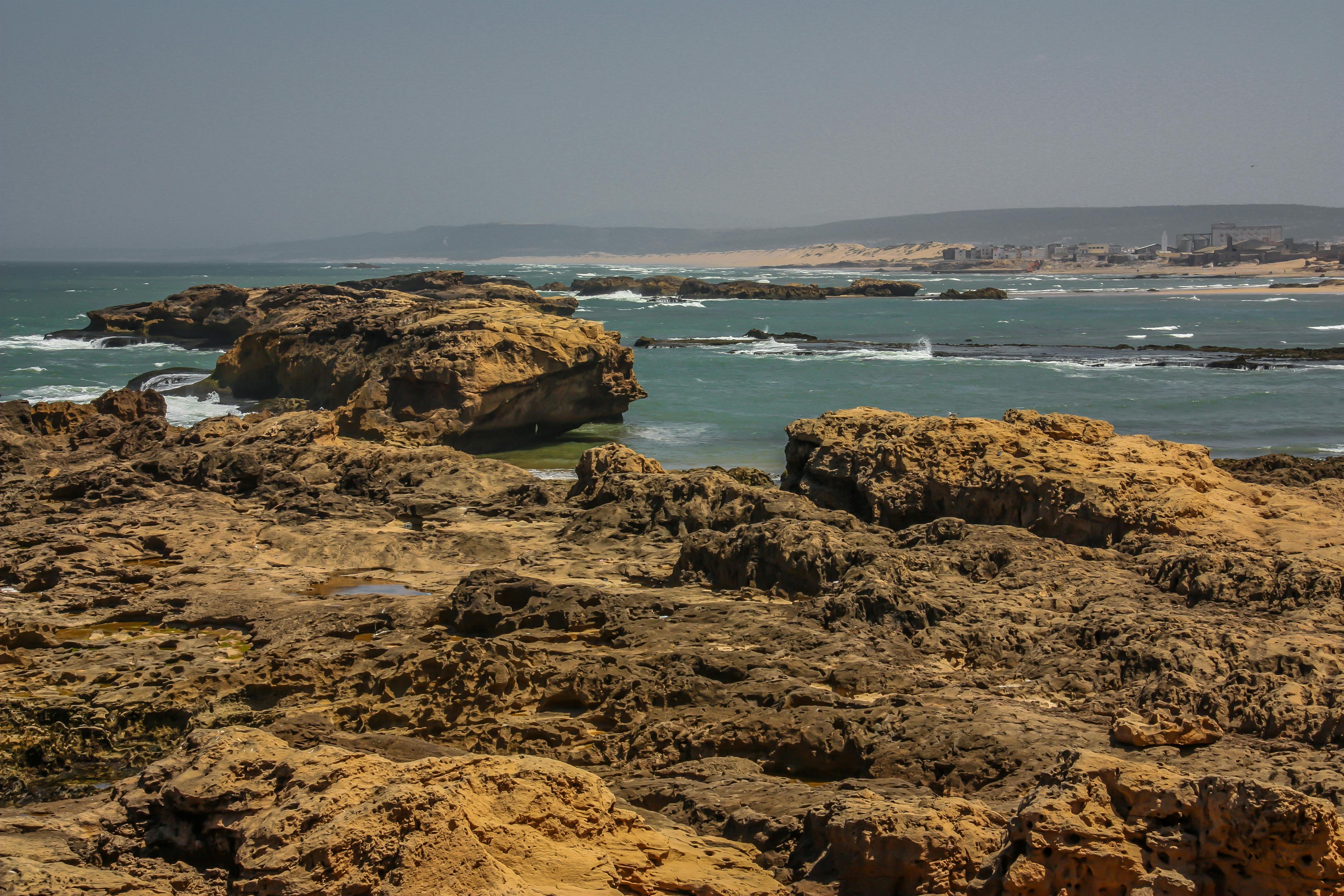 Brown Rock Formation on Sea Shore · Free Stock Photo