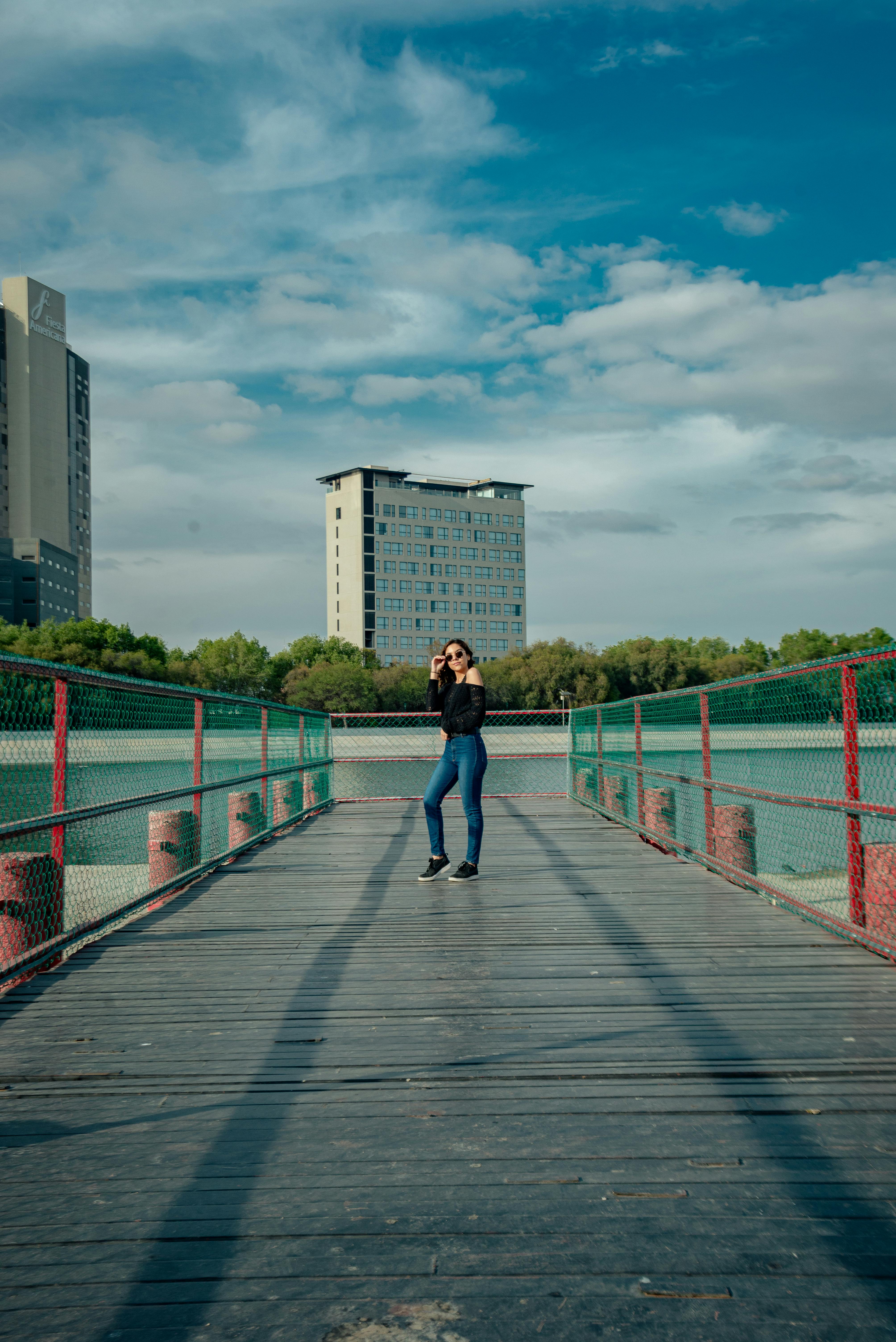 Girl Posing on Bridge · Free Stock Photo