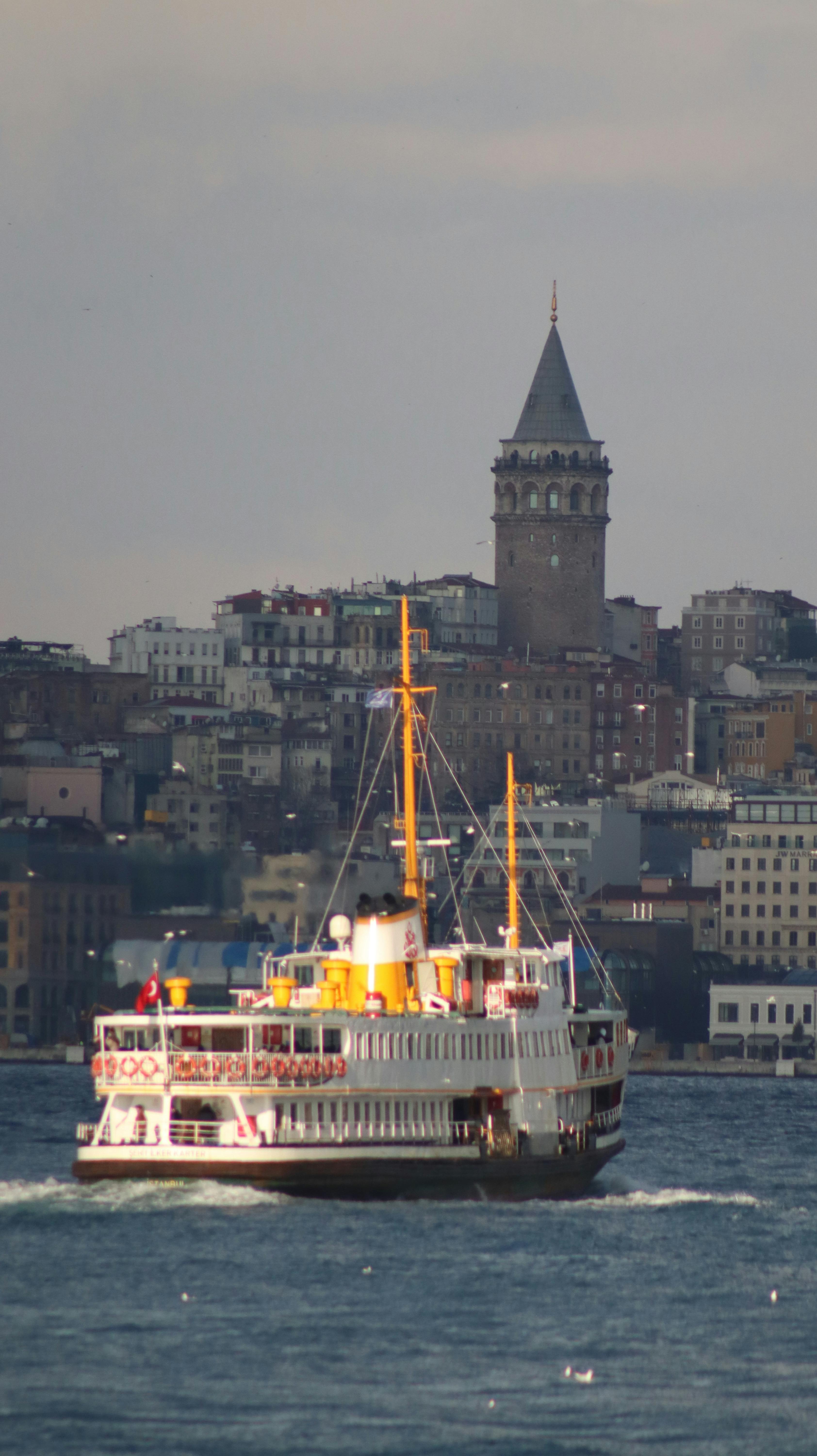 White Ship on Body of Water Near City Buildings · Free Stock Photo