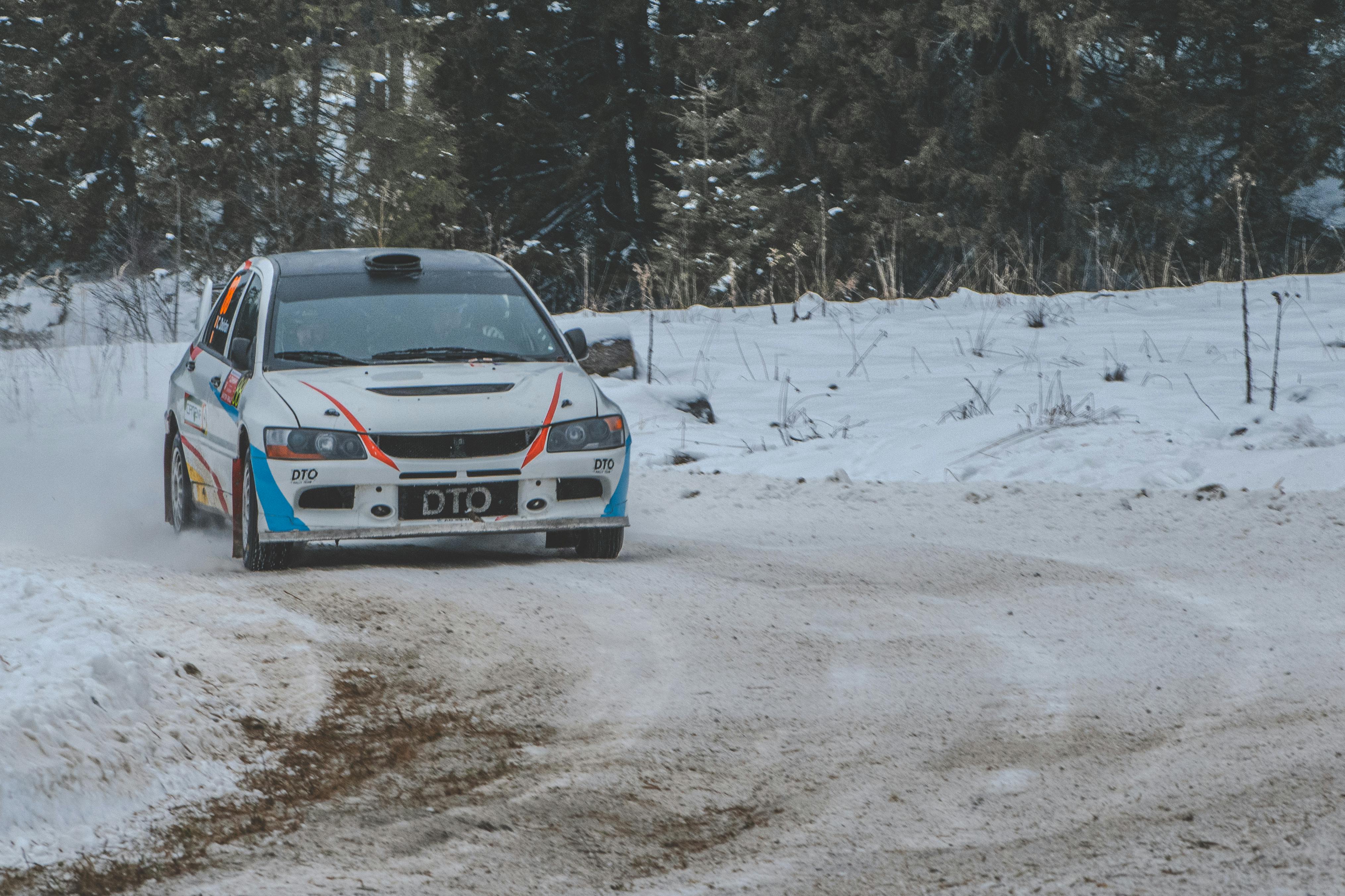 A Car Moving on a Snow Covered Ground · Free Stock Photo