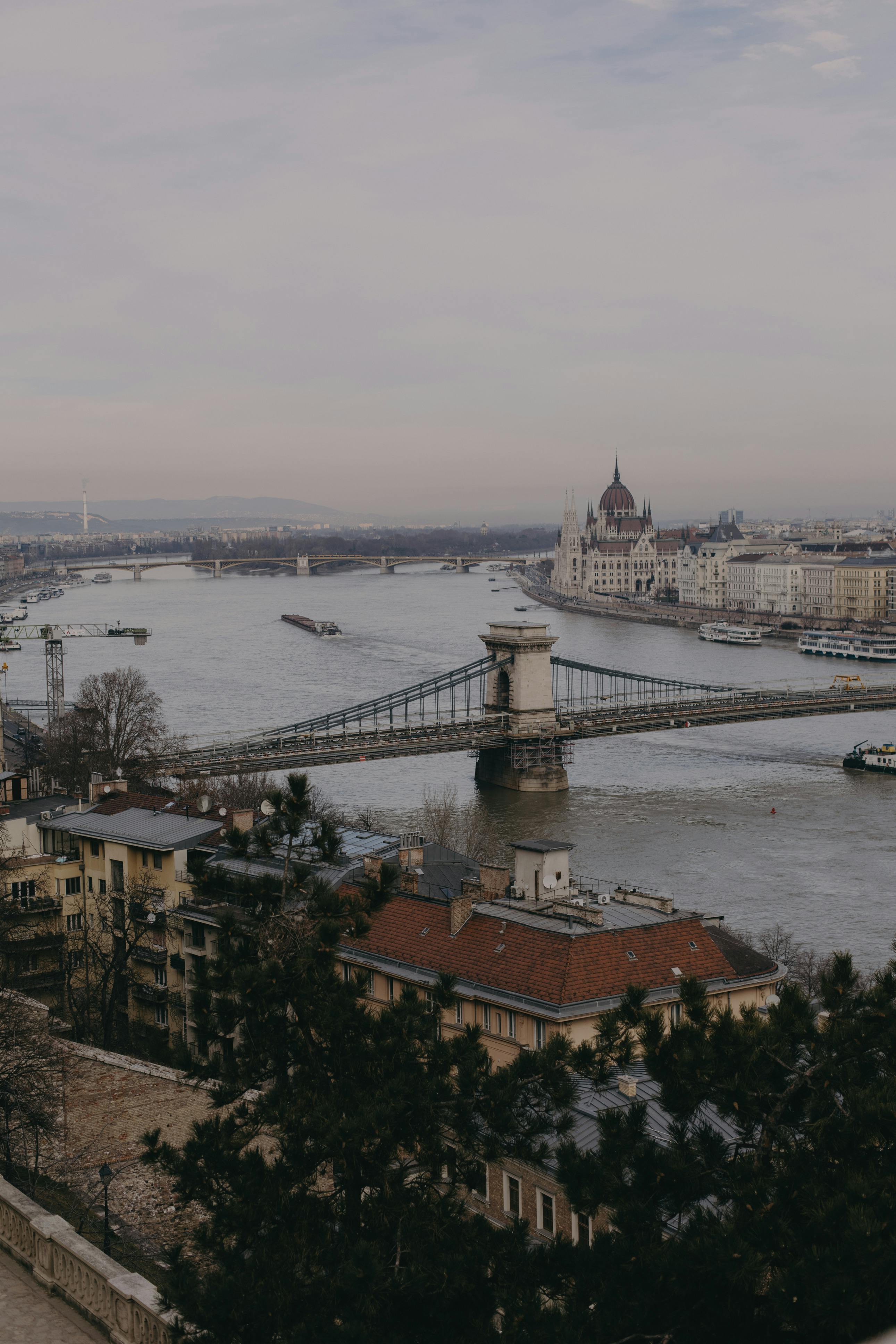 A Bridge Over a River Between Buildings of a City · Free Stock Photo