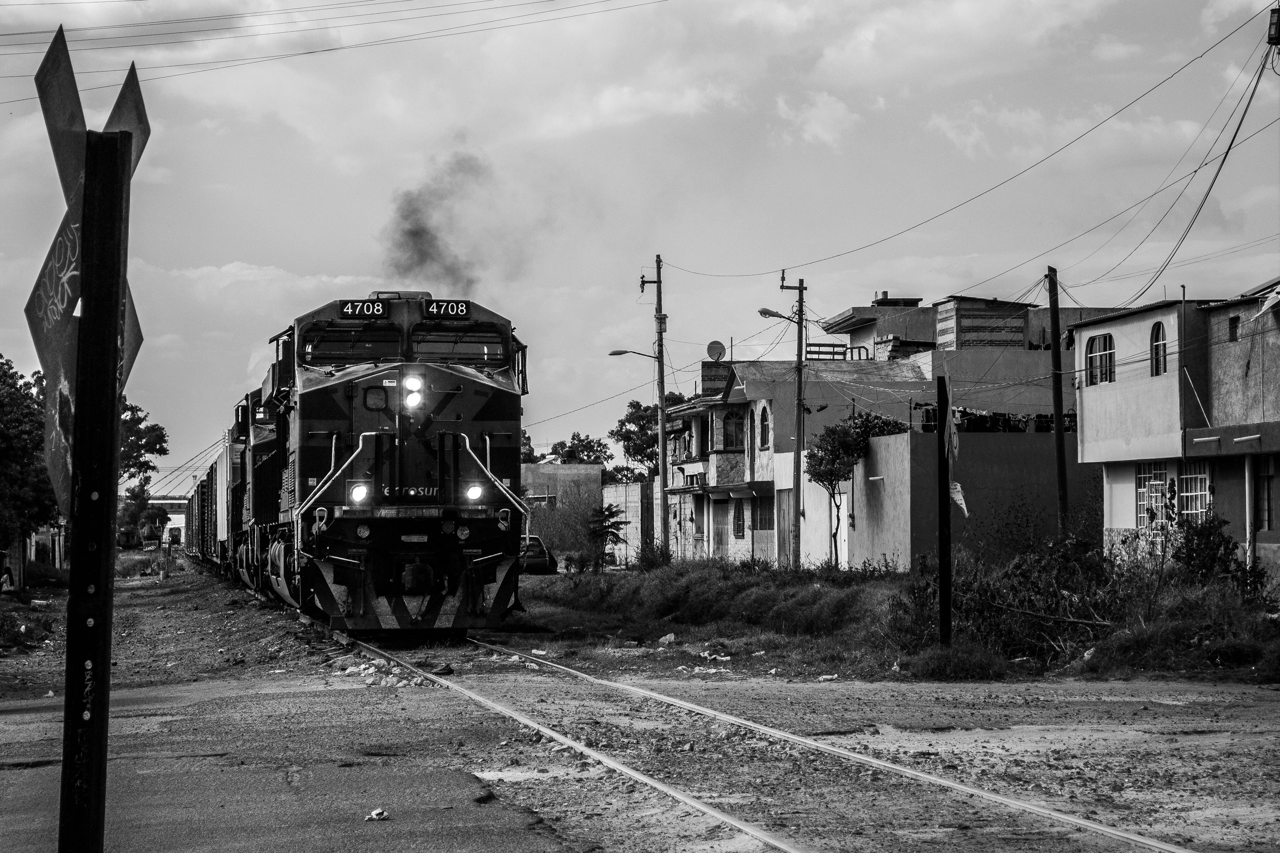 Grayscale Photo of Train on Rail Tracks · Free Stock Photo